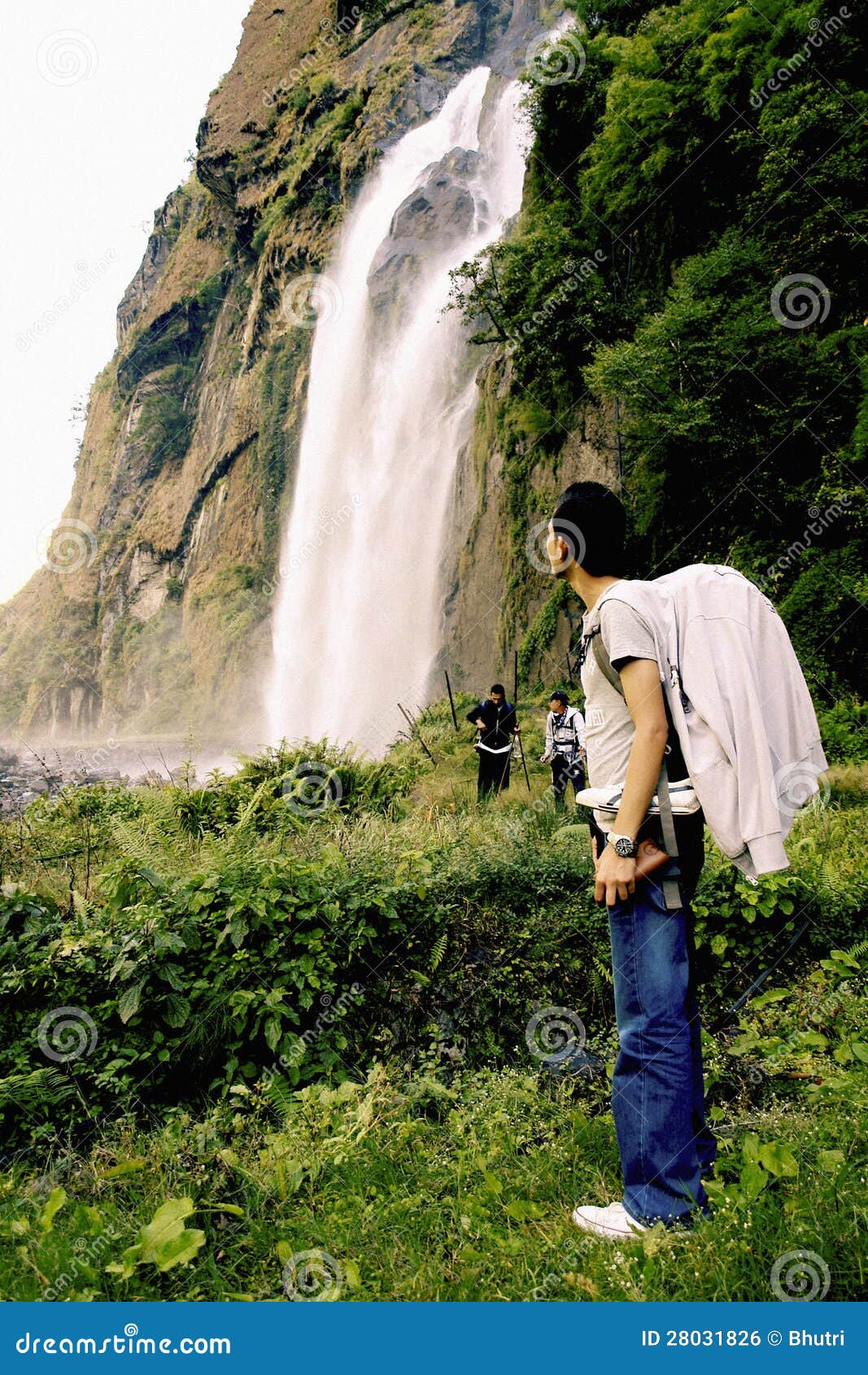 Tourist enjoying waterfall stock photo. Image of garden - 28031826