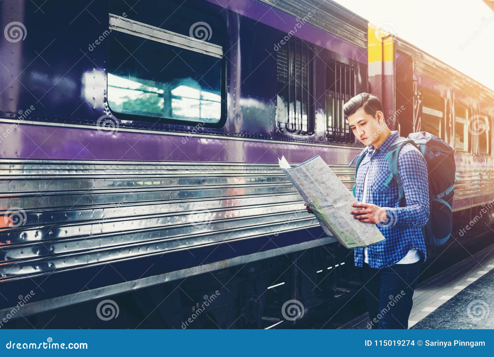 Tourist Man Backpacker Using Map To Travel at Train Station Stock Photo ... Tourist Man Backpacker Using Map To Travel at Train Station Stock Photo ...