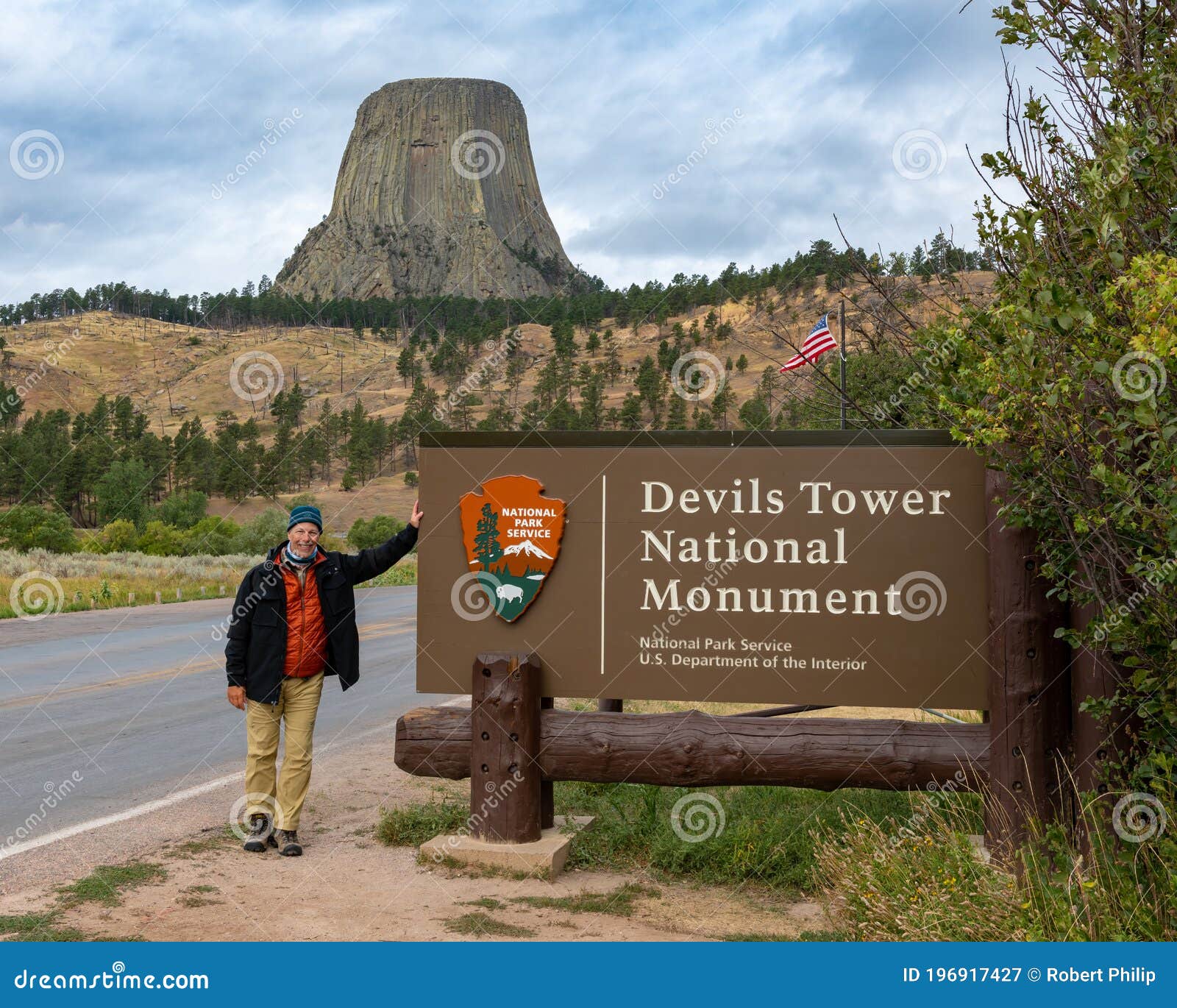 A Tourist Next the Sign of Devils Tower National Monument in Wyoming ...