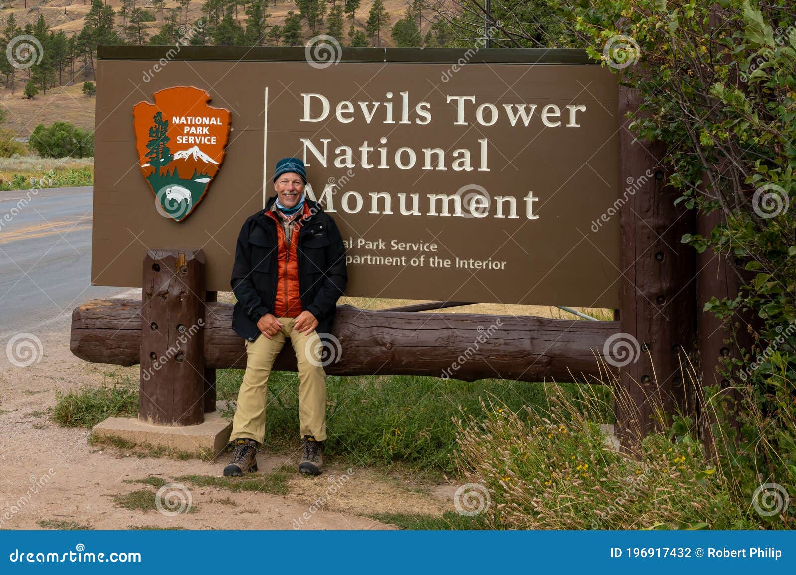 A Tourist Next the Sign of Devils Tower National Monument in Wyoming ...