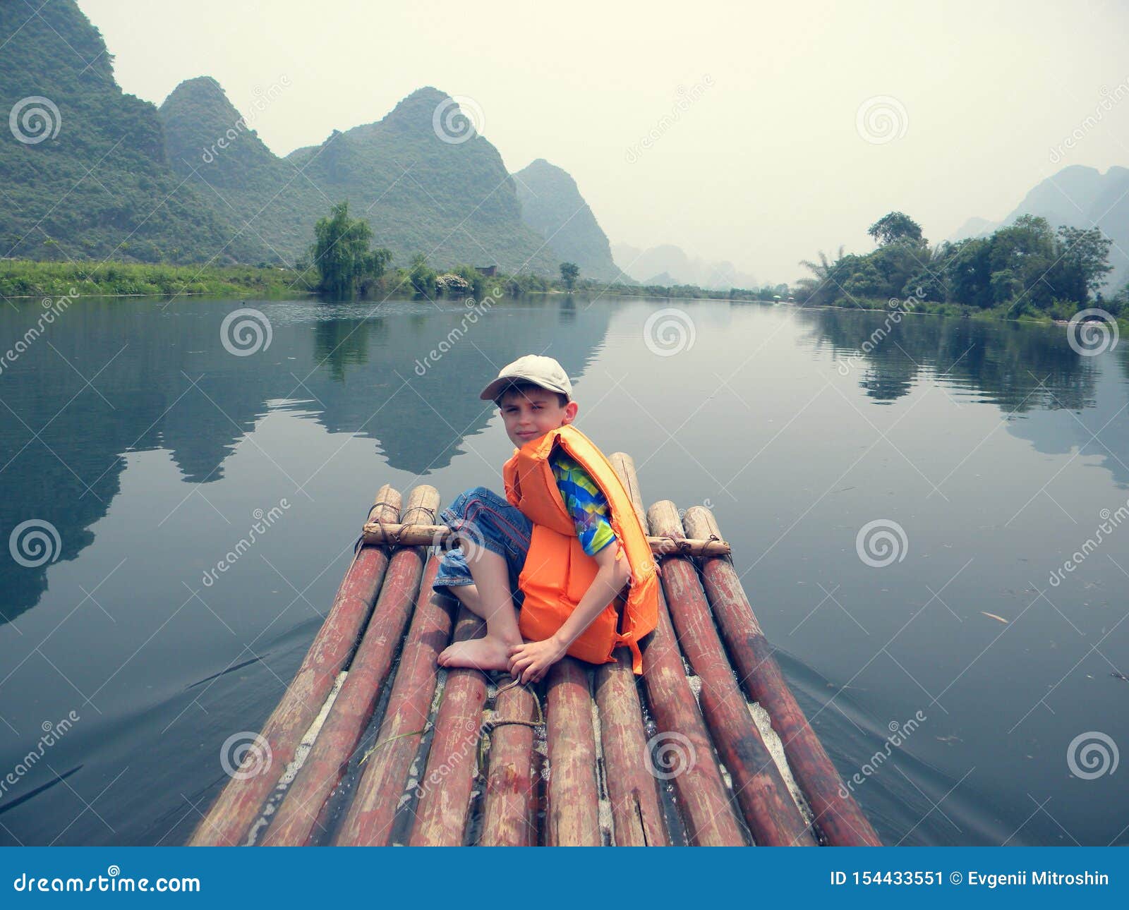 Tourists Rafting Along the Yangshuo River, a Raft Boy Stock Image ...