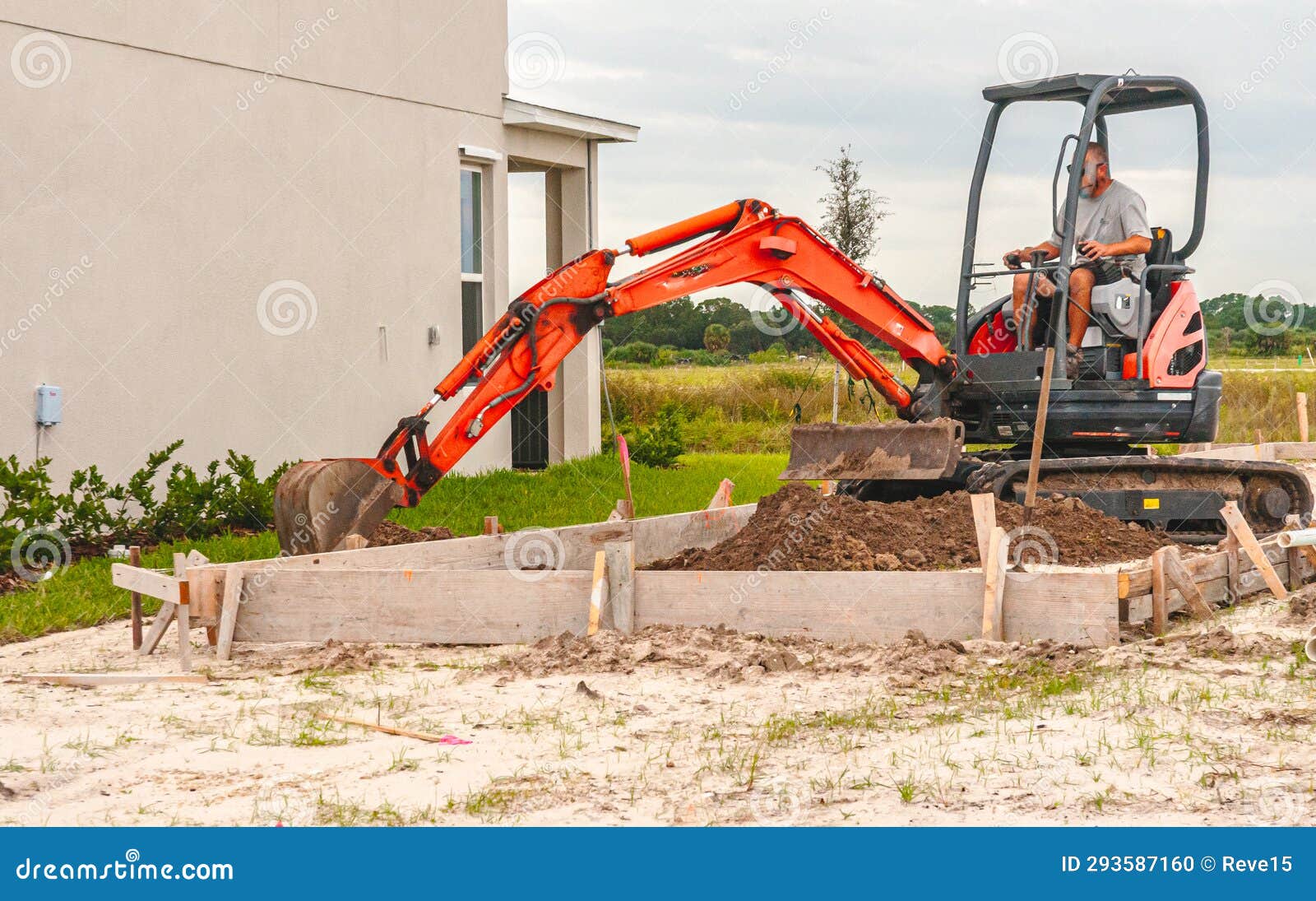 Towable Backhoe Moving Dirt into Slab, Wood Form Stock Photo - Image of ...