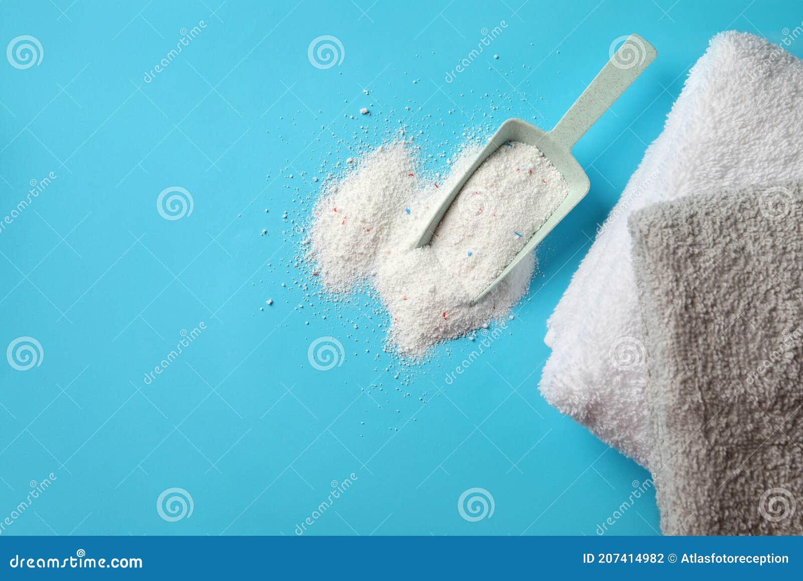 Towels and Scoop with Washing Powder on Blue Background Stock Photo ...