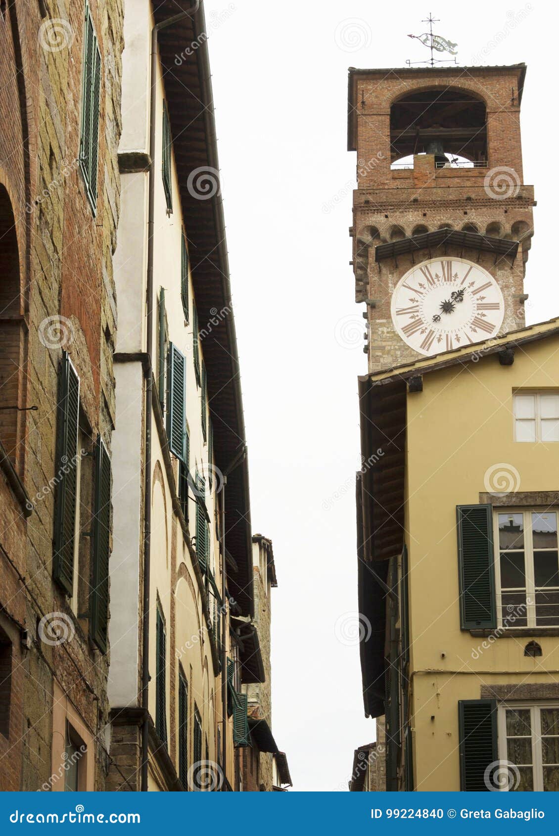 Tower Clock in Lucca through Buildings Editorial Image - Image of ...