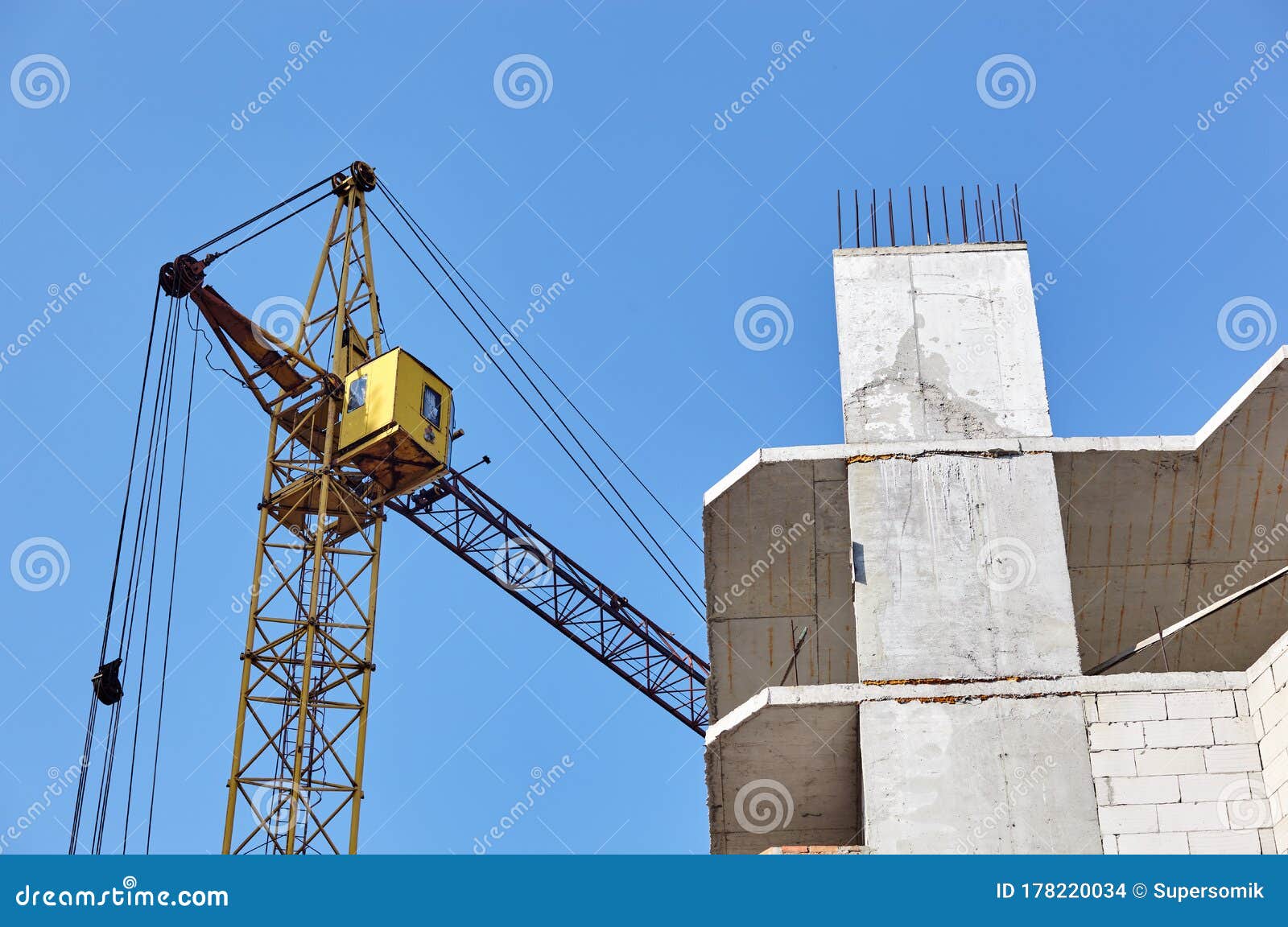 Tower Crane Building a House. Concrete Building Under Construction ...