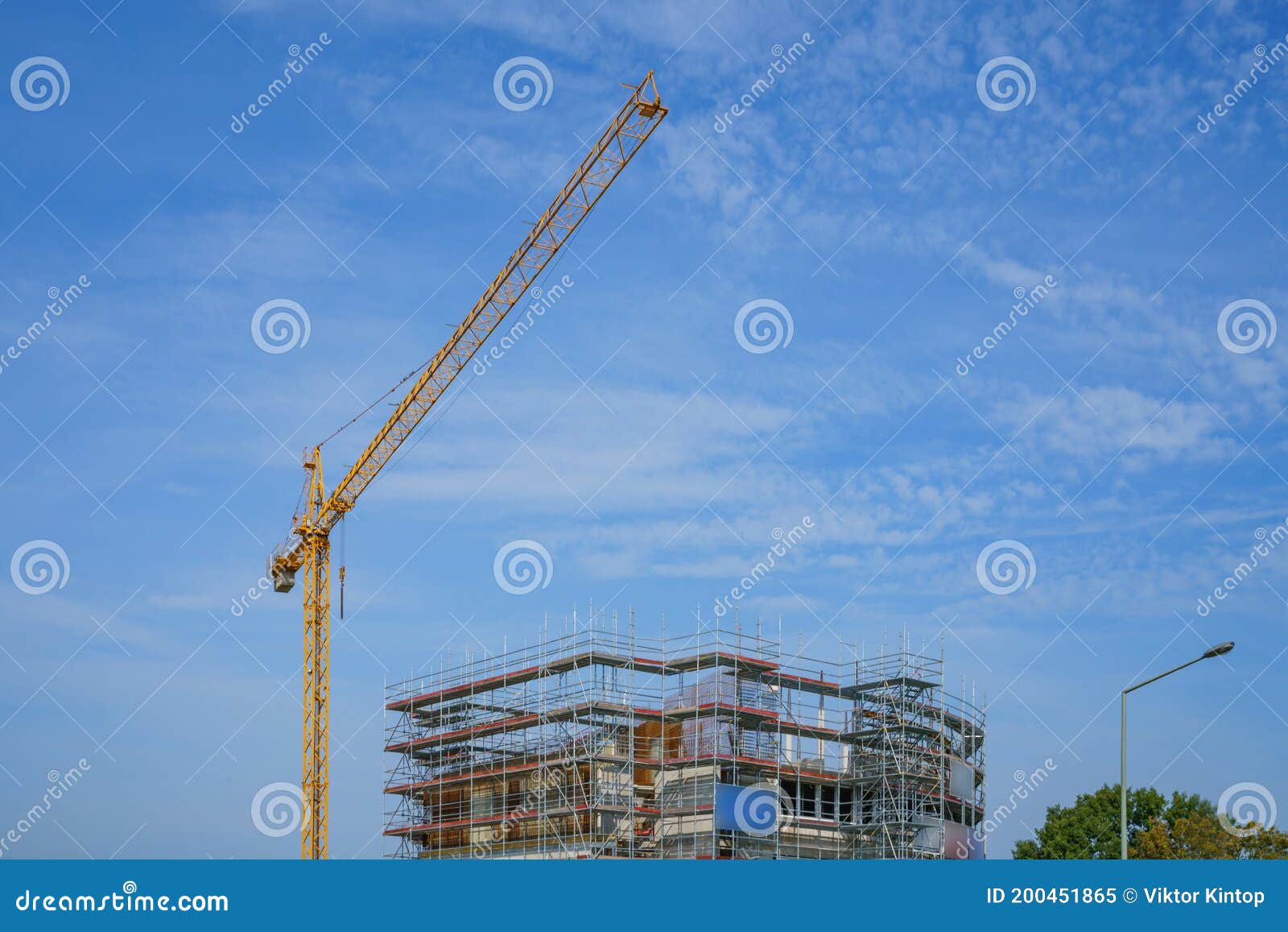 Tower Crane Over a Building Under Construction. Against the Backdrop of ...