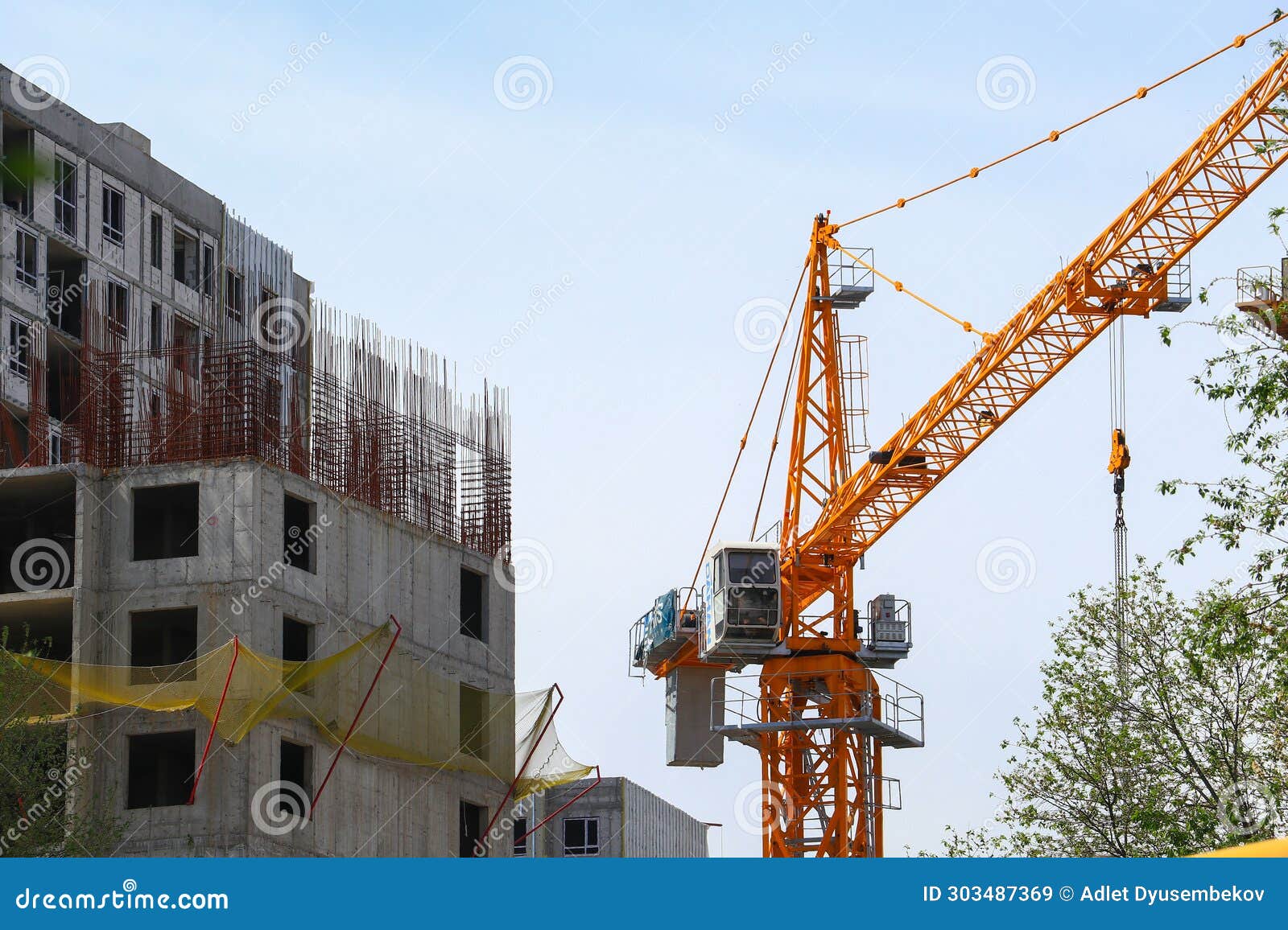 A Tower Crane among a Thicket of Trees and Buildings during the ...