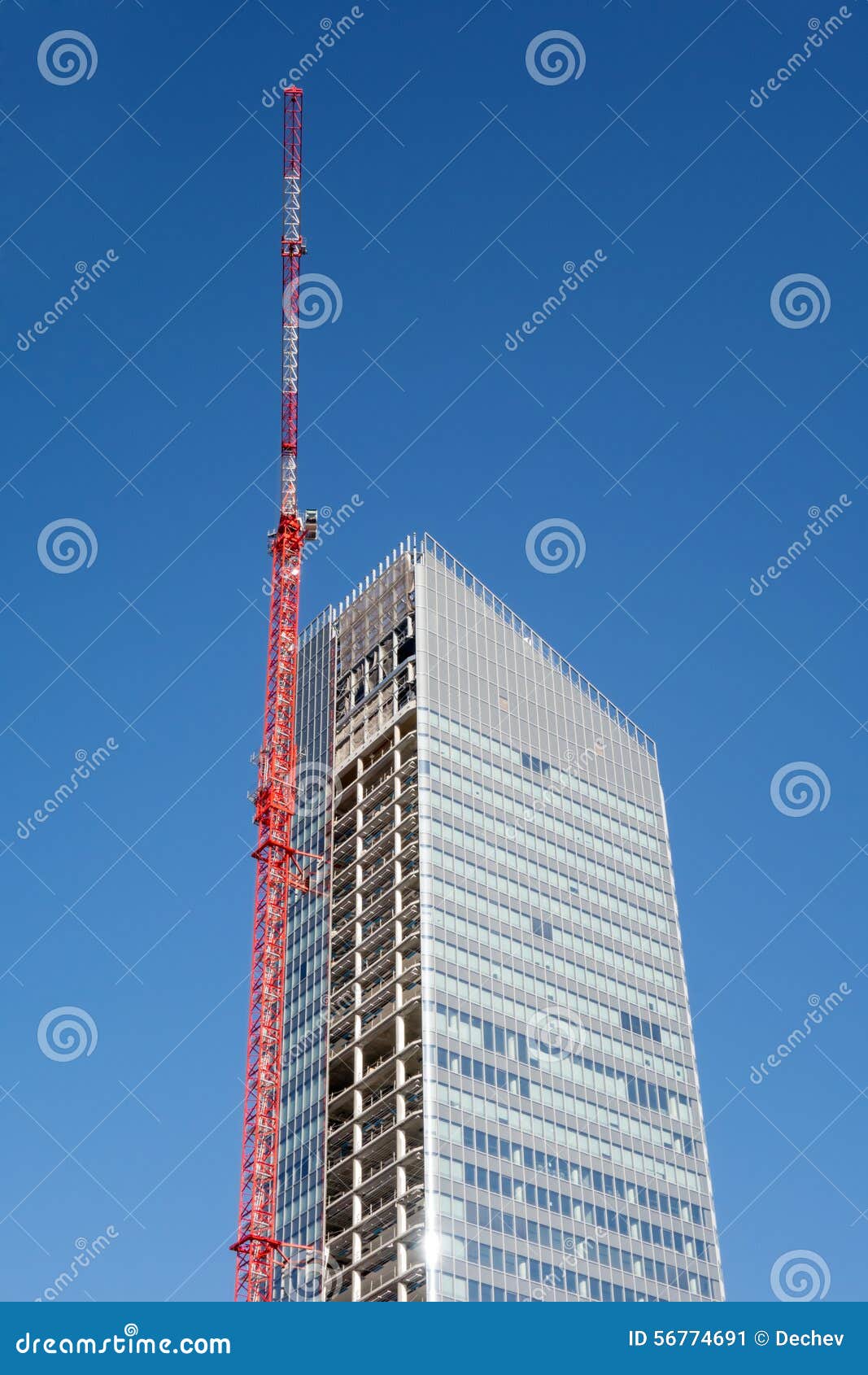 Tower Crane on Top of Construction Skyscraper Building Over Blue Sky ...
