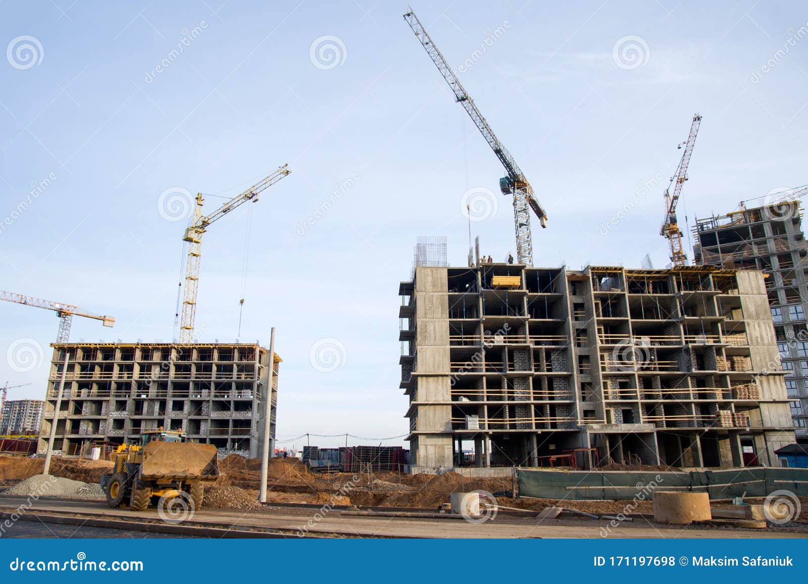 Tower Cranes Constructing a New Residential Build. Pouring Concrete ...