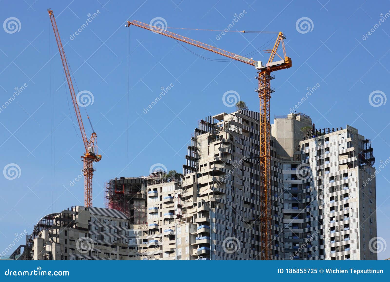 Tower Cranes Working on a High Rise Building Under Construction Stock ...