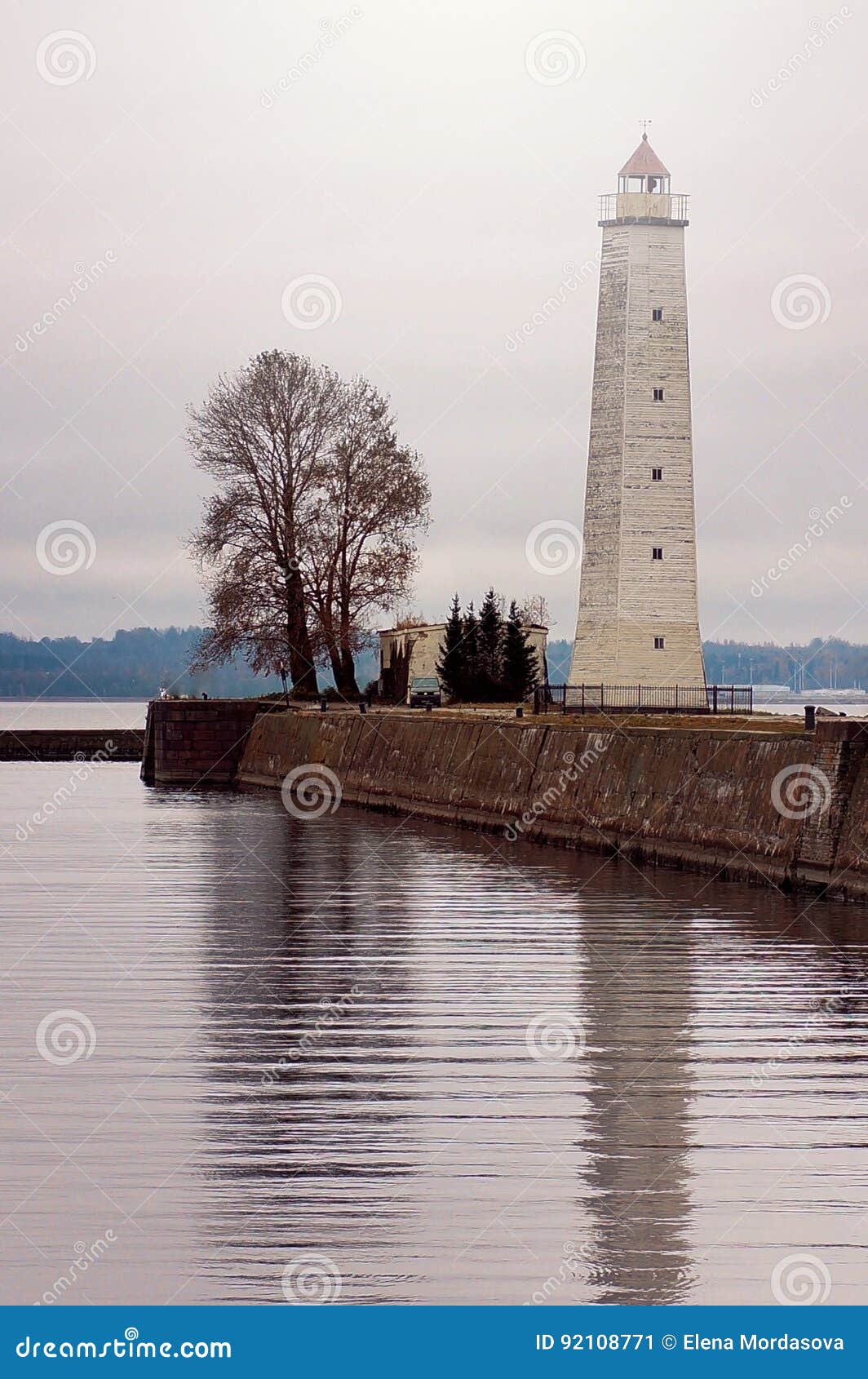Tower Lighthouse Stands on the Bank of a Canal Next To a Tree ...