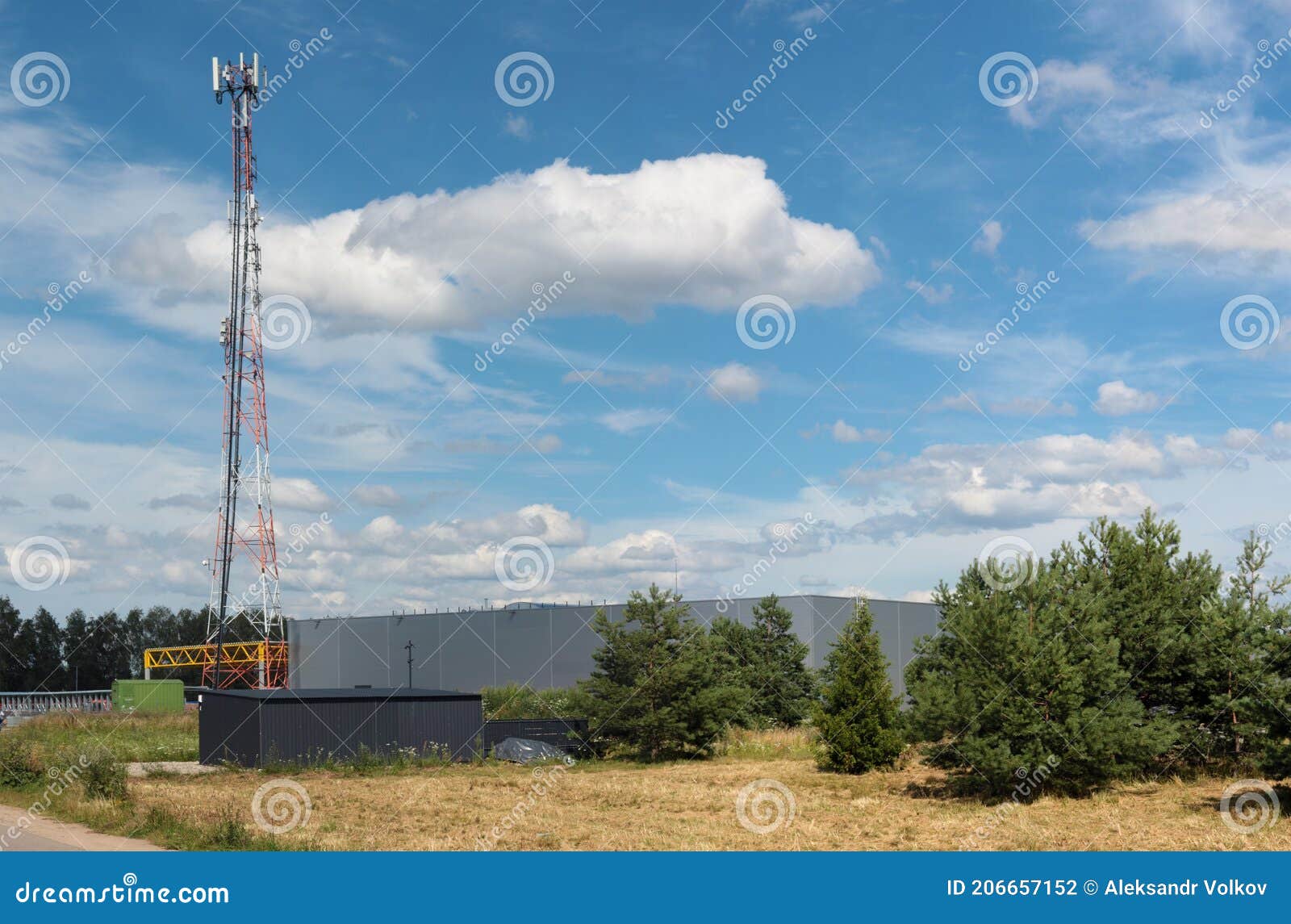 A Tower with Mobile Communication Equipment Next To a Large Commercial ...