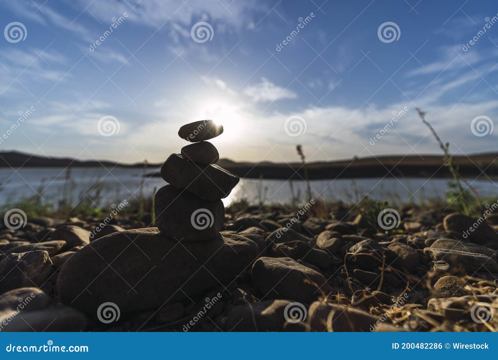 Tower of Rocks on the Shore by a Lake Stock Photo - Image of beach ...