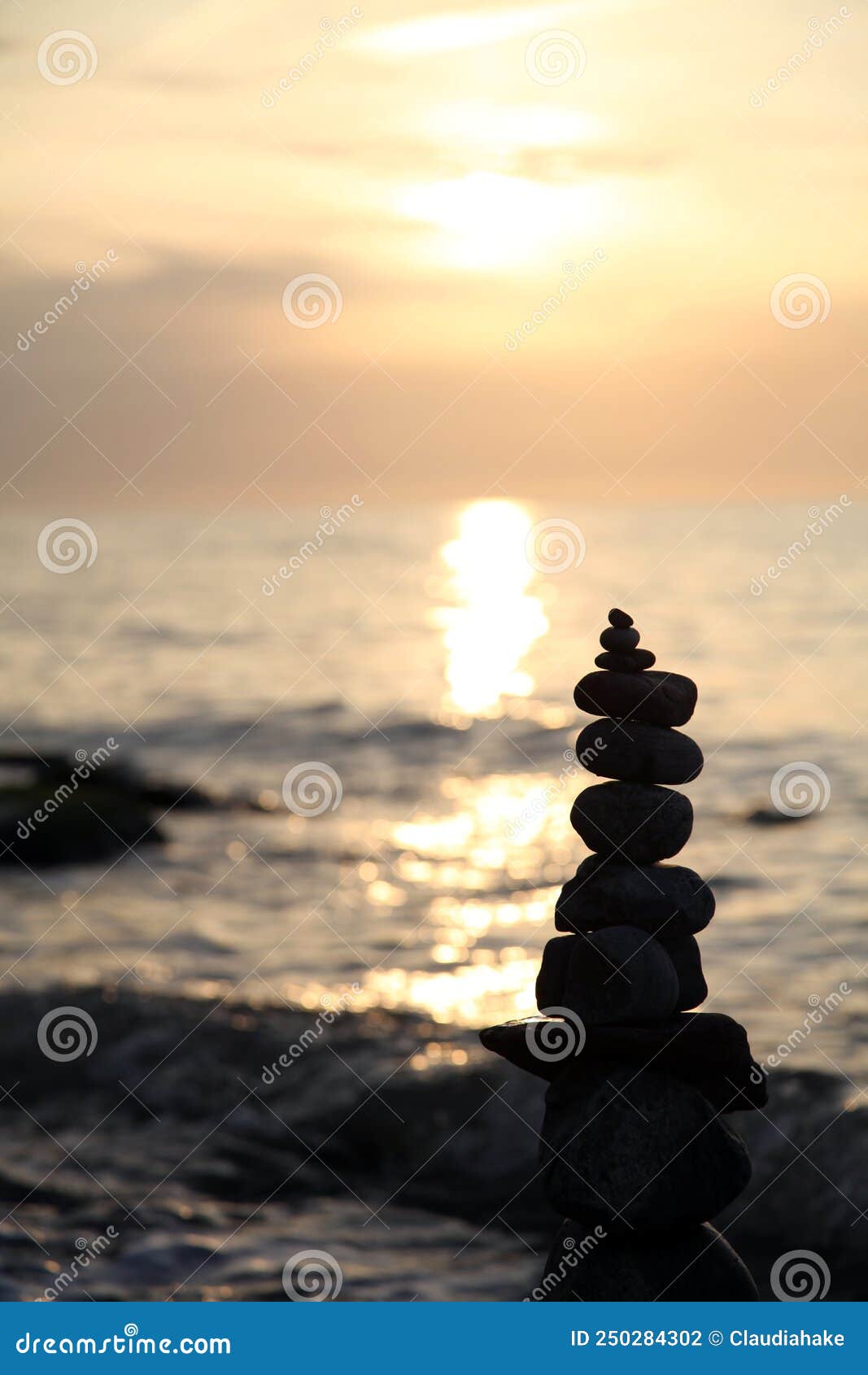 Tower of stones at sunset stock photo. Image of sign - 250284302