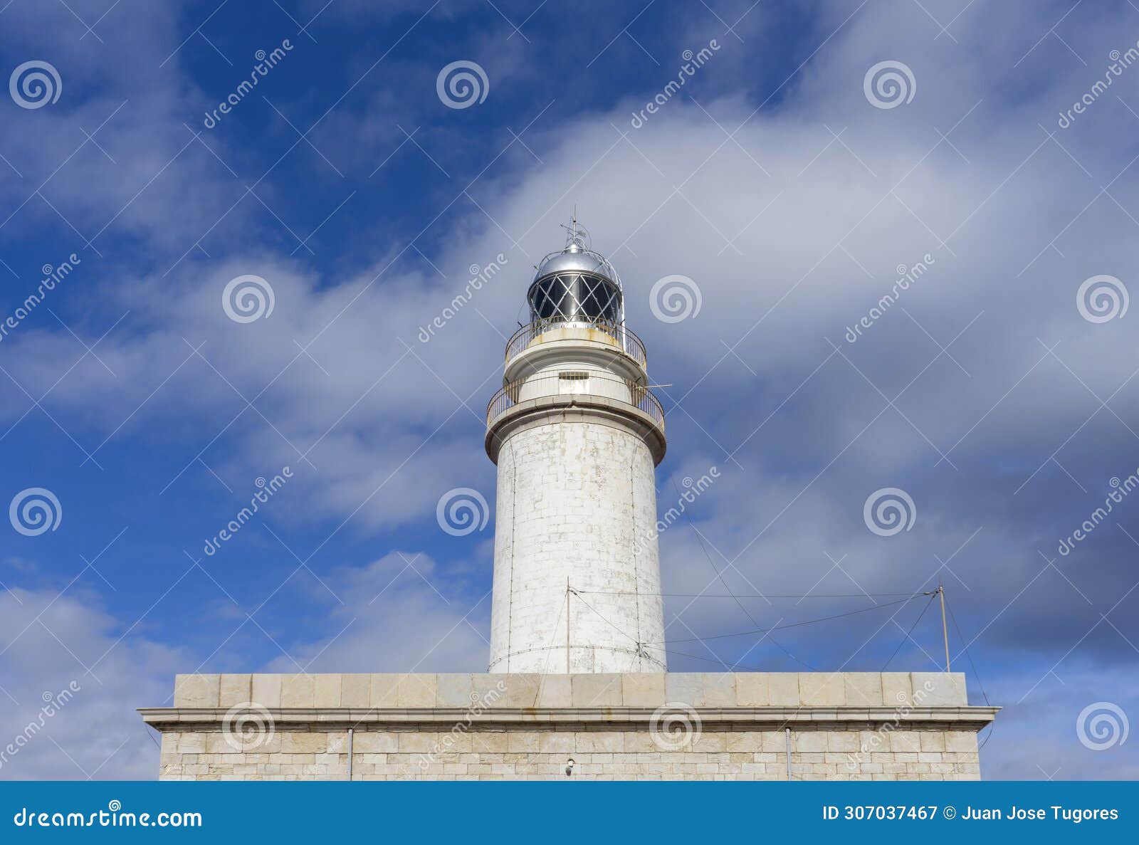 Majestic Lighthouse Standing Guard Against a Cloudy Sky Stock Image ...