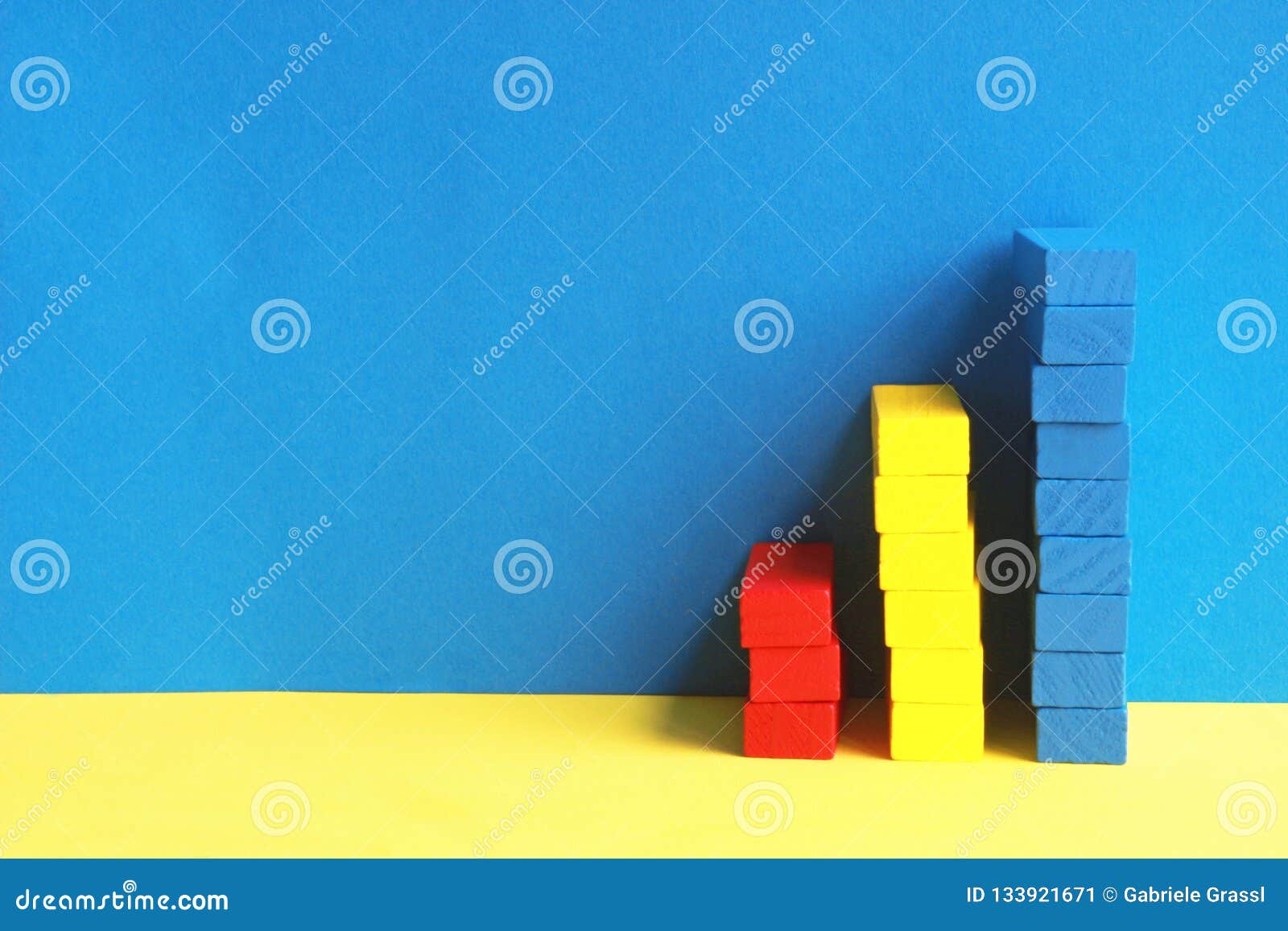 Towers of Red, Yellow and Blue Toy Blocks in Front of Blue Wall Stock ...