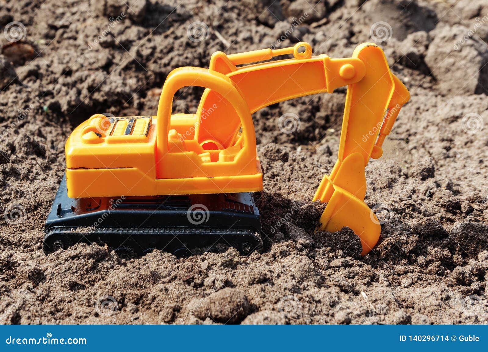 Toy Excavator Digging the Ground. the Concept of Land Works Stock Photo ...
