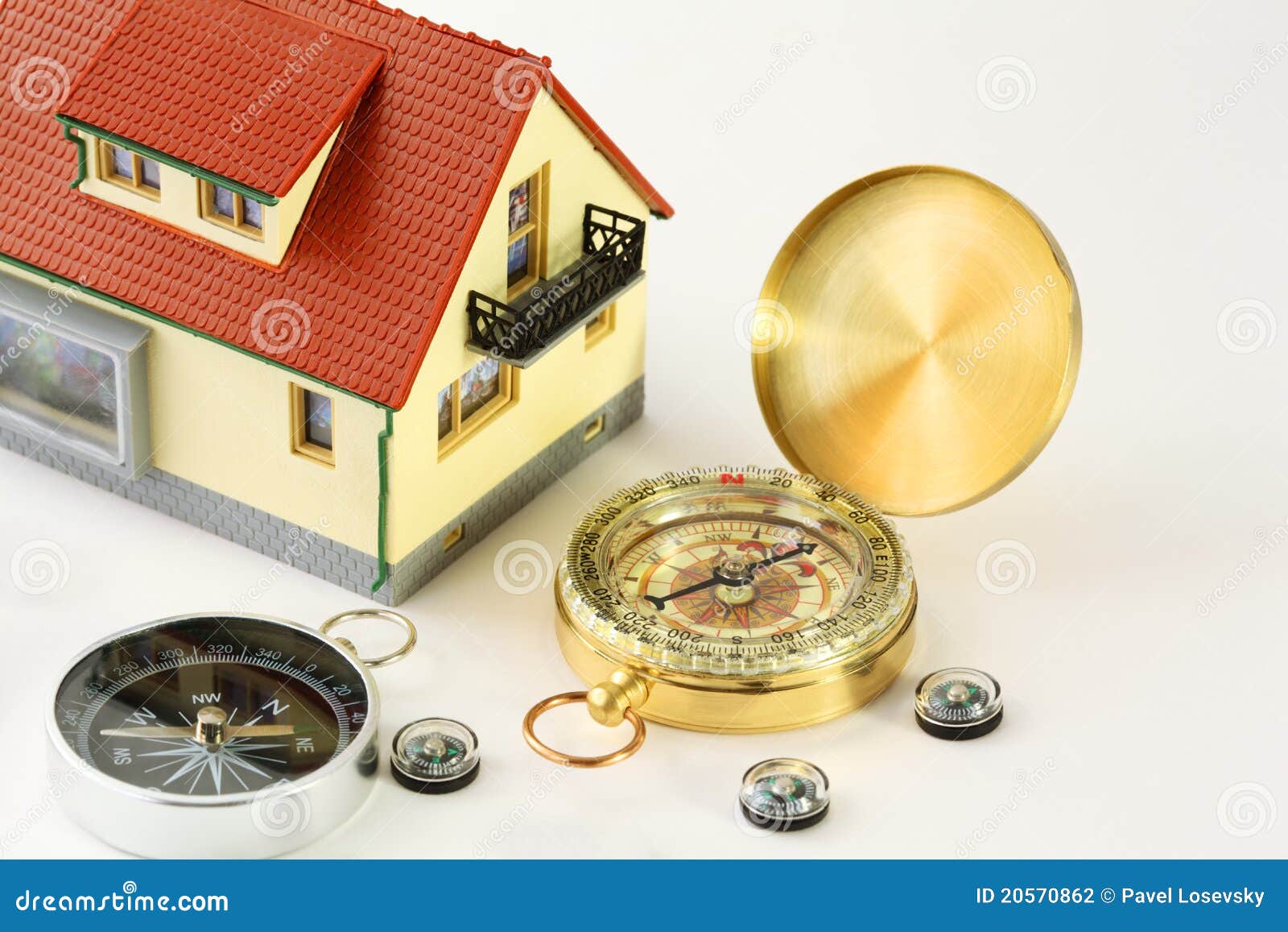 Toy House and Seven Different Compasses Isolated Stock Photo - Image of ...