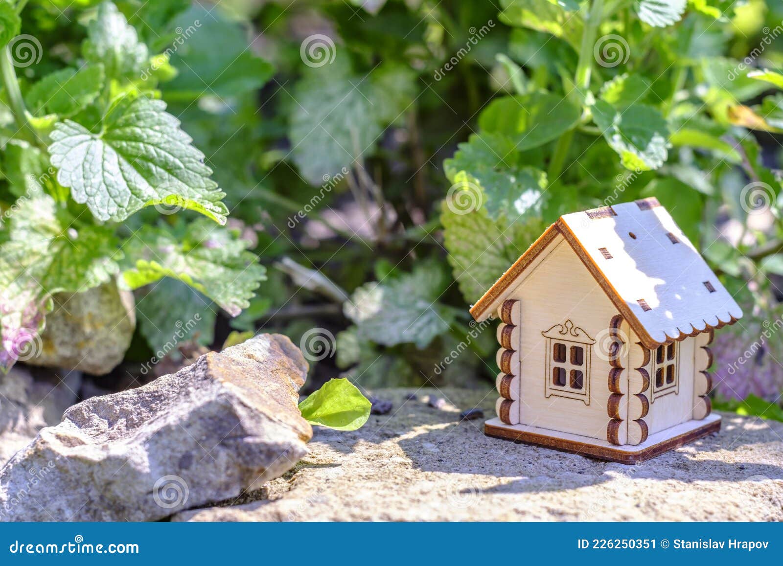 Toy House on Stone with Greenery Background Stock Image - Image of ...