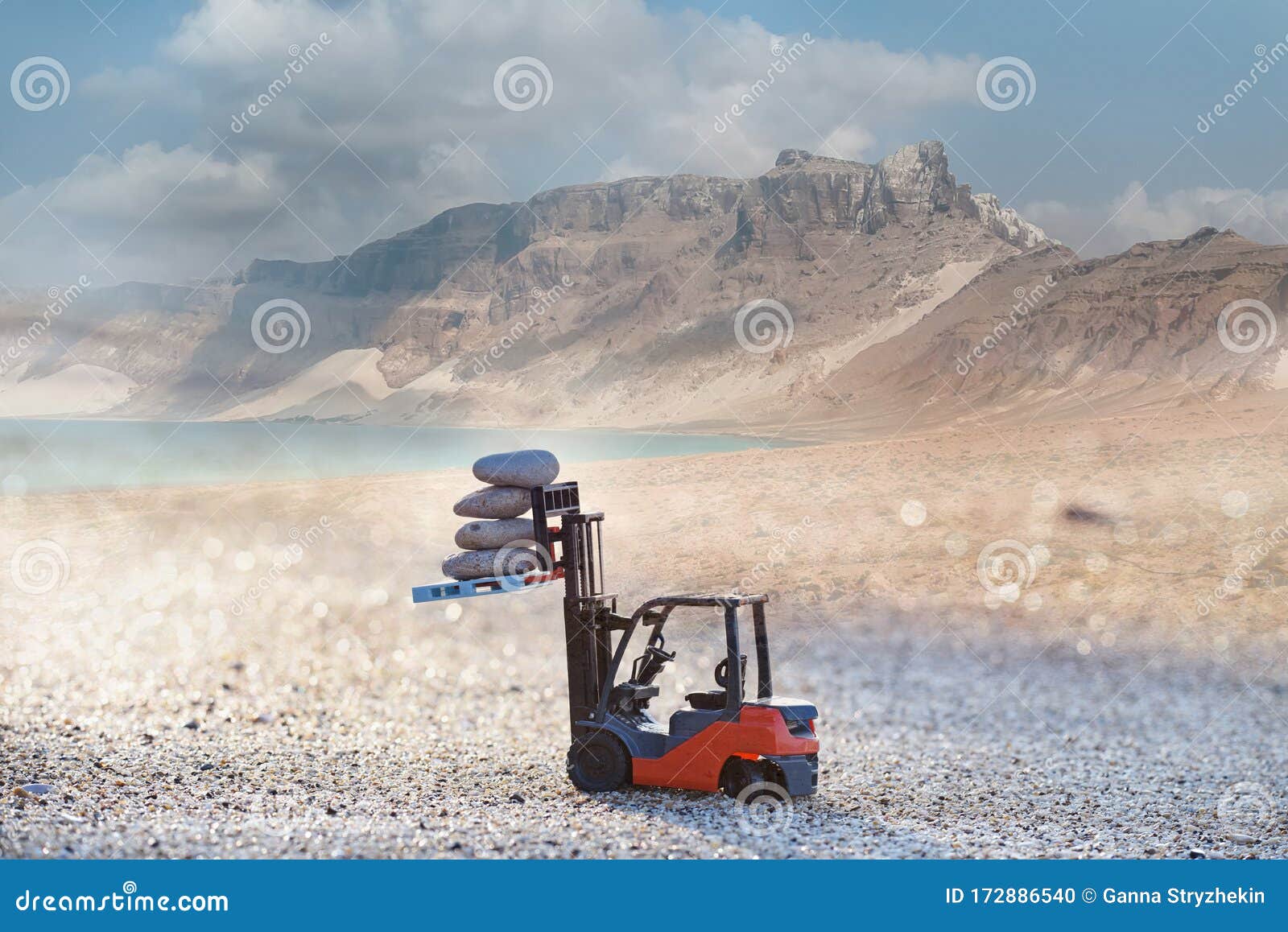 Toy Loader Loads Stones on a Sandy Landscape. Loading and Construction ...