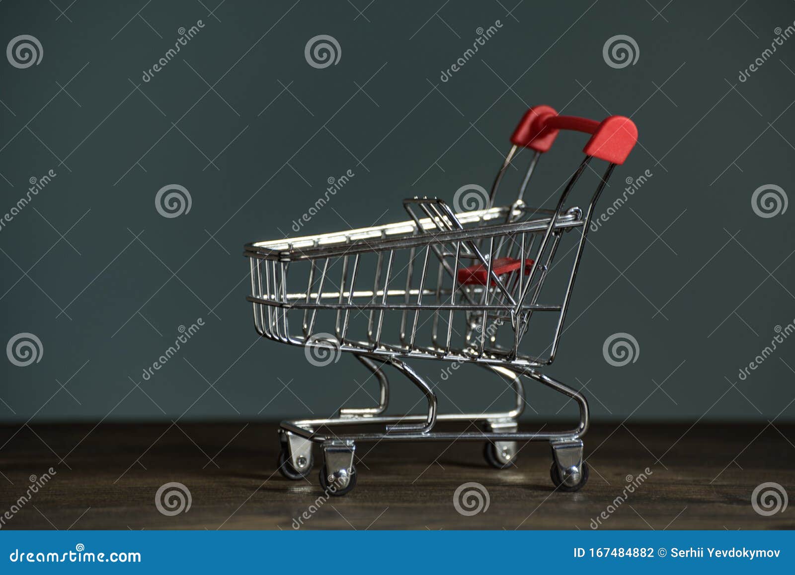 Toy Metal Shopping Trolley on Table on a Dark Background. Side View ...