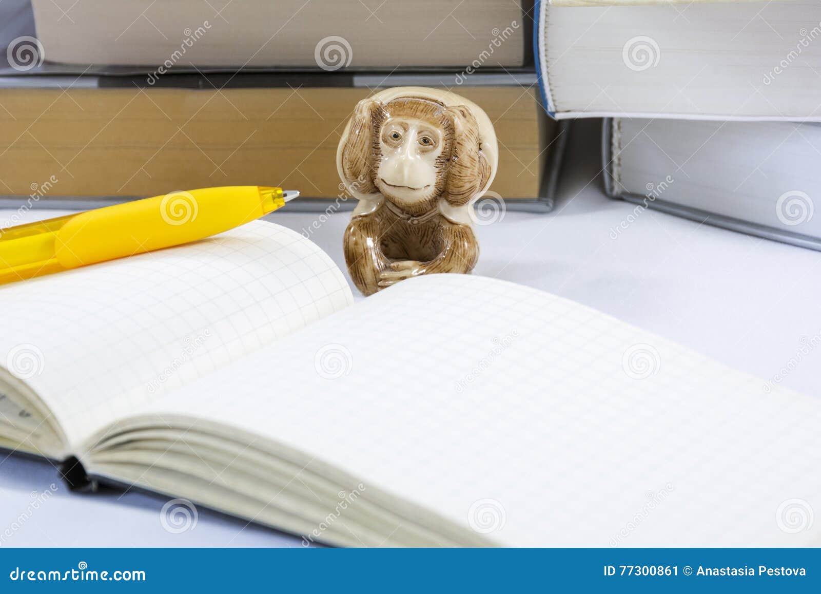 Toy Monkey with Notepad and Pencil and Many Thick Books Stock Image ...