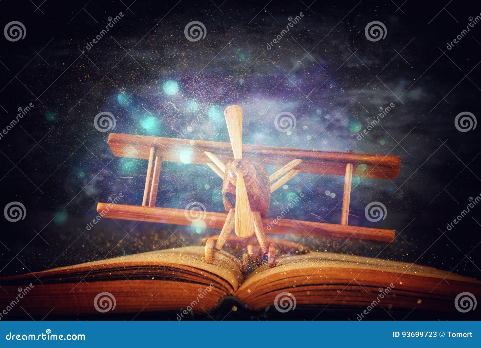 Toy Plane and the Open Book on Wooden Table with Glitter Lights Stock ...