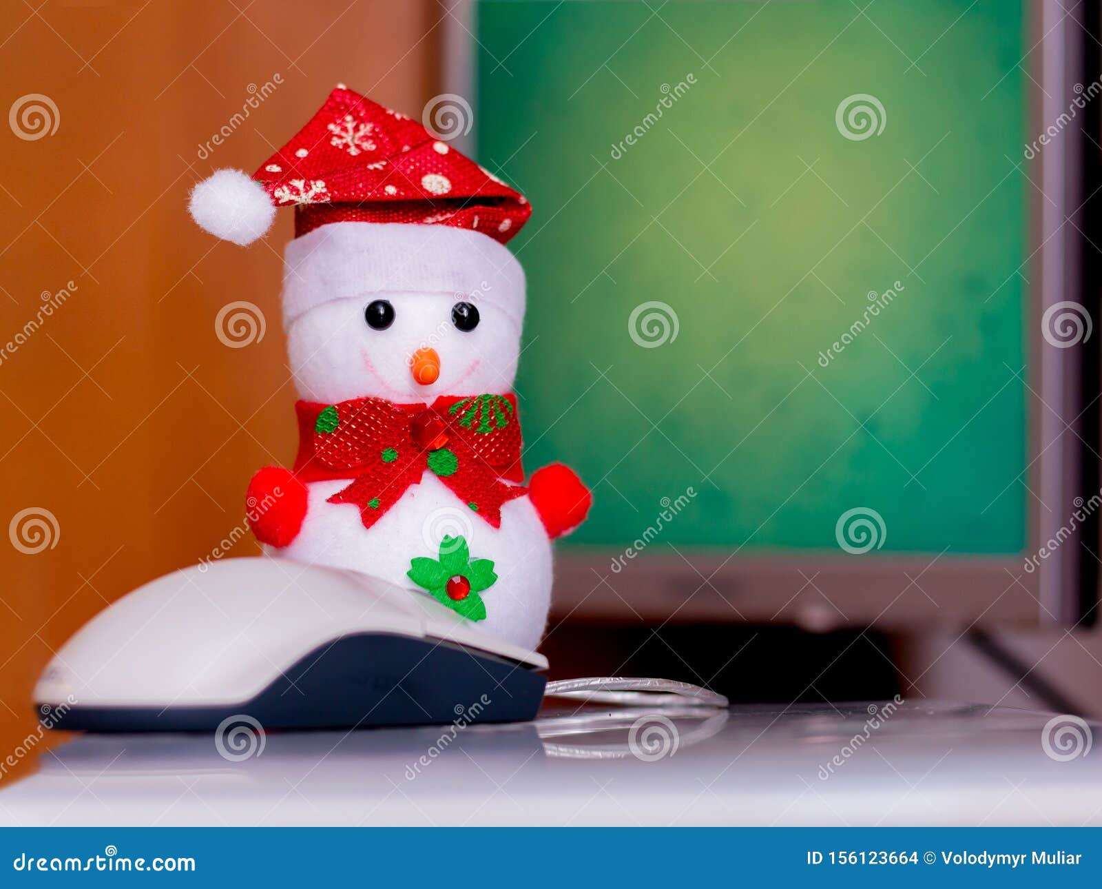 Toy Snowman Near Computer. Working in the Office at the Computer ...