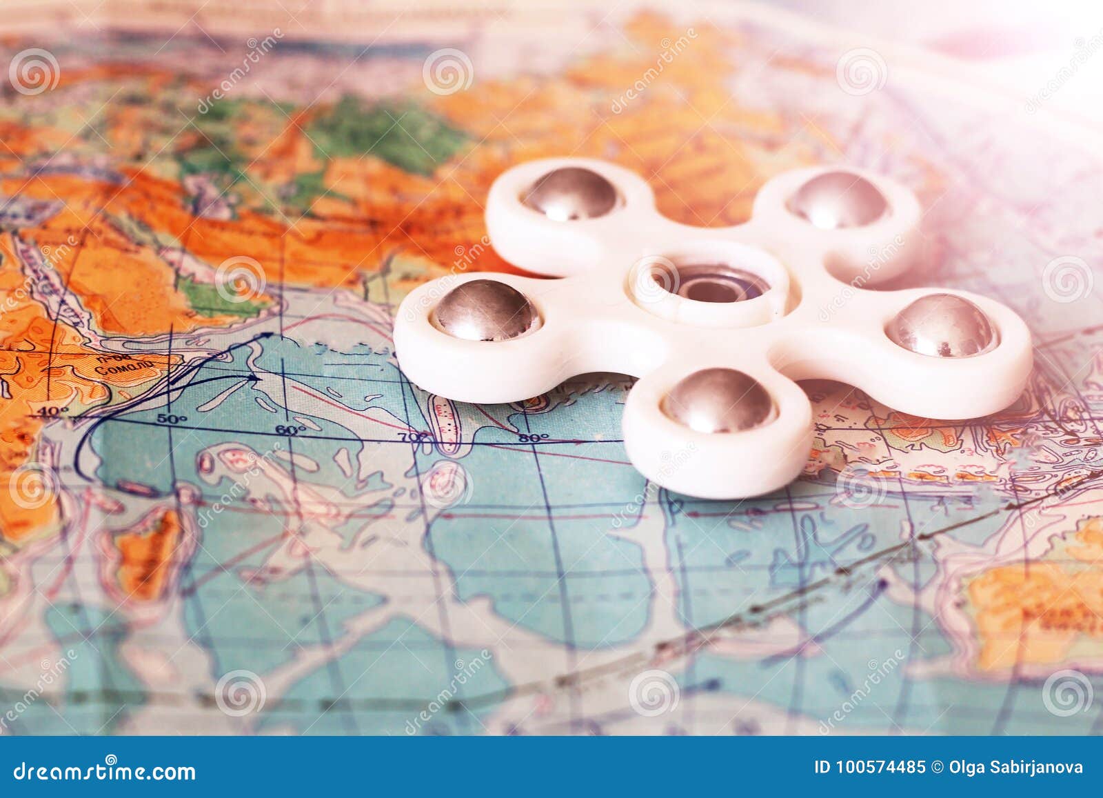 Toy spinner on the map stock image. Image of bearings - 100574485