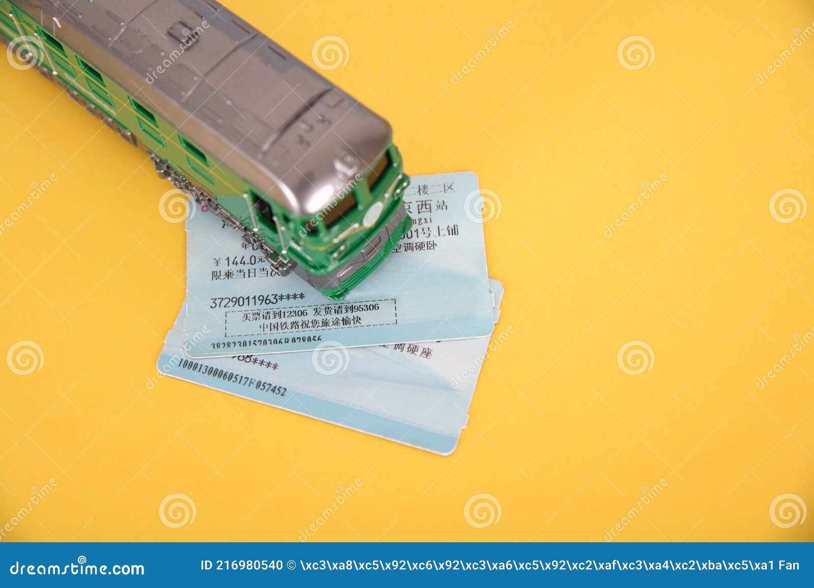A Toy Train and Two Train Tickets on a Yellow Background Stock Photo ...