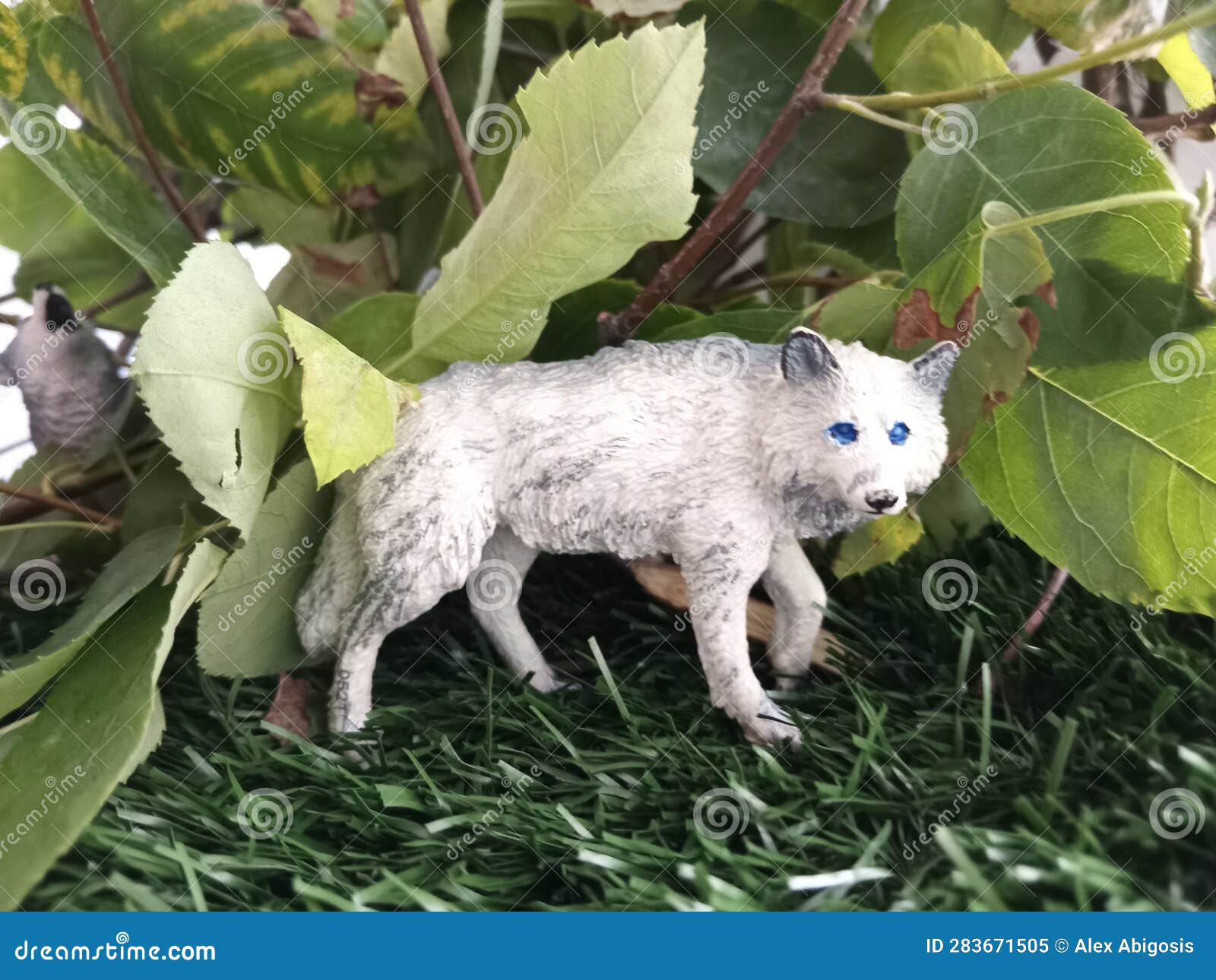 Toy Wolf Figures in a Forest Setting with Trees and Grass Stock Image ...