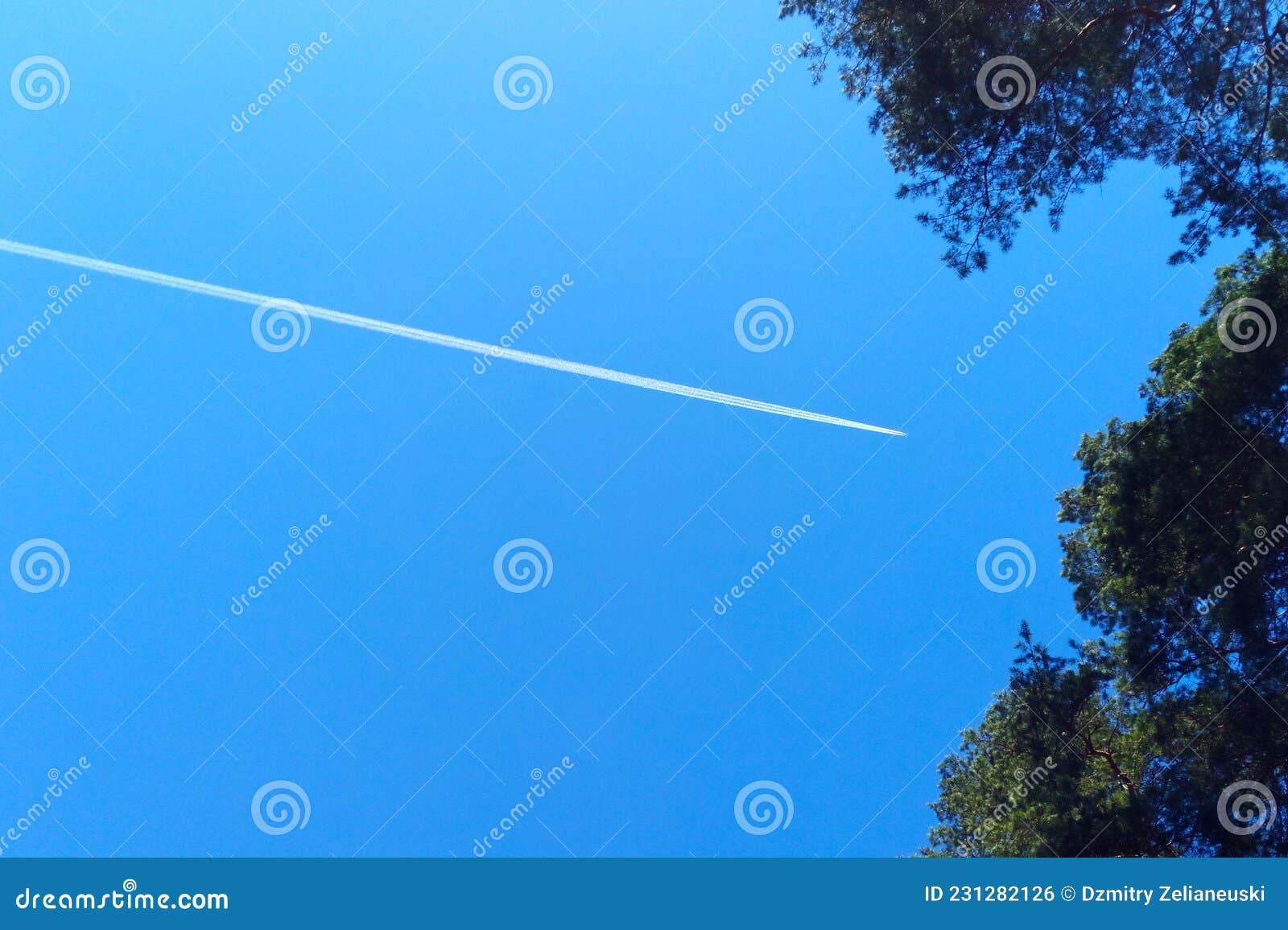 A Trace of a Flying Plane in the Blue Sky Stock Photo - Image of ...