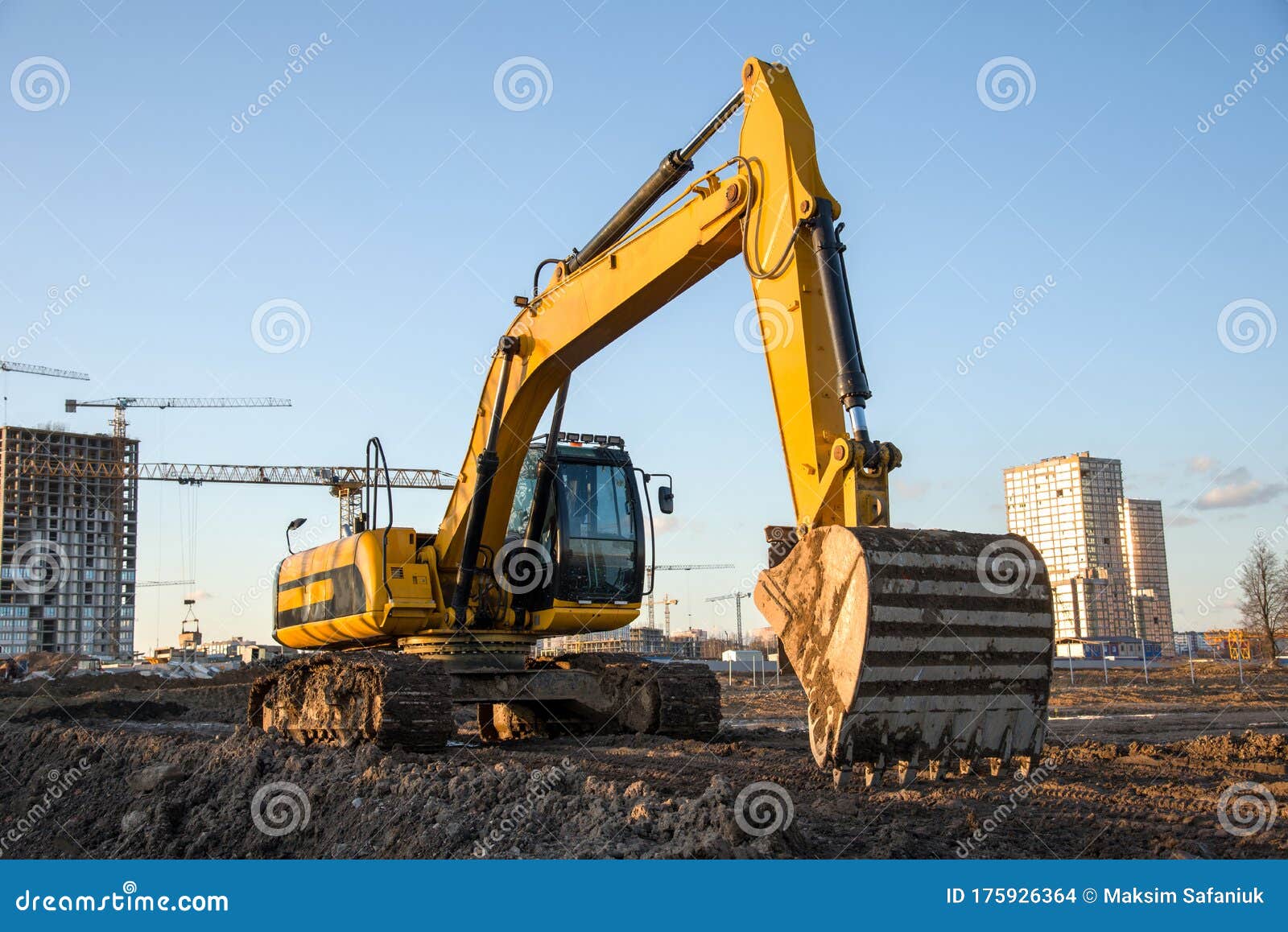 Excavator During Earthmoving At Construction Site On Sunset Background ...