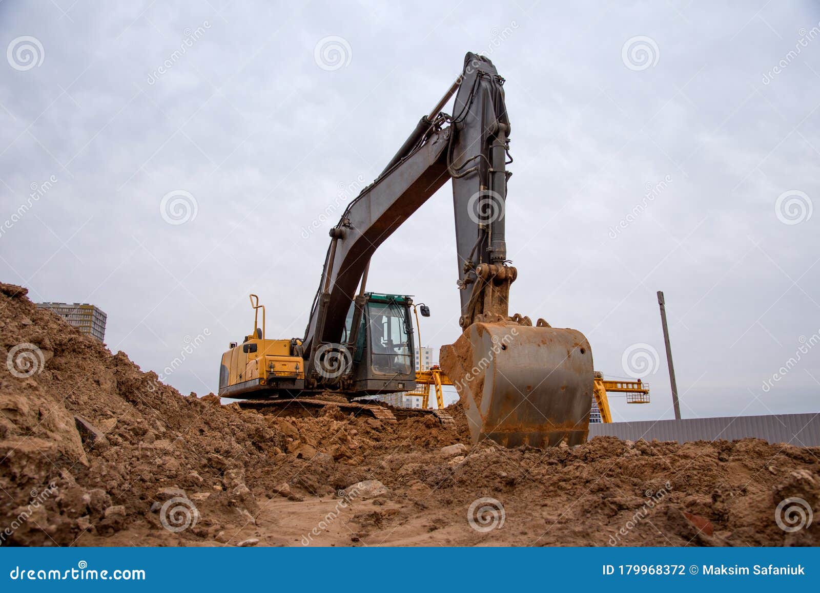 Track-type Excavator during Earthmoving at Construction Site. Backhoe ...