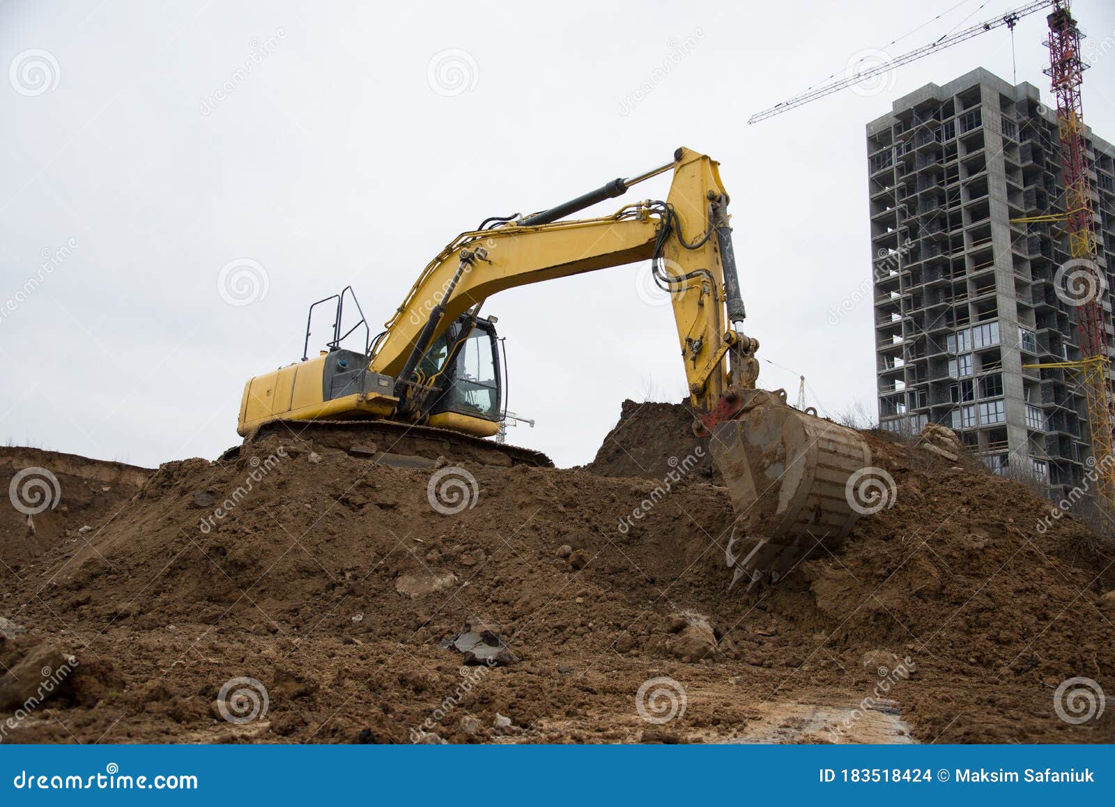 Track-type Excavator during Earthmoving at Construction Site. Backhoe ...