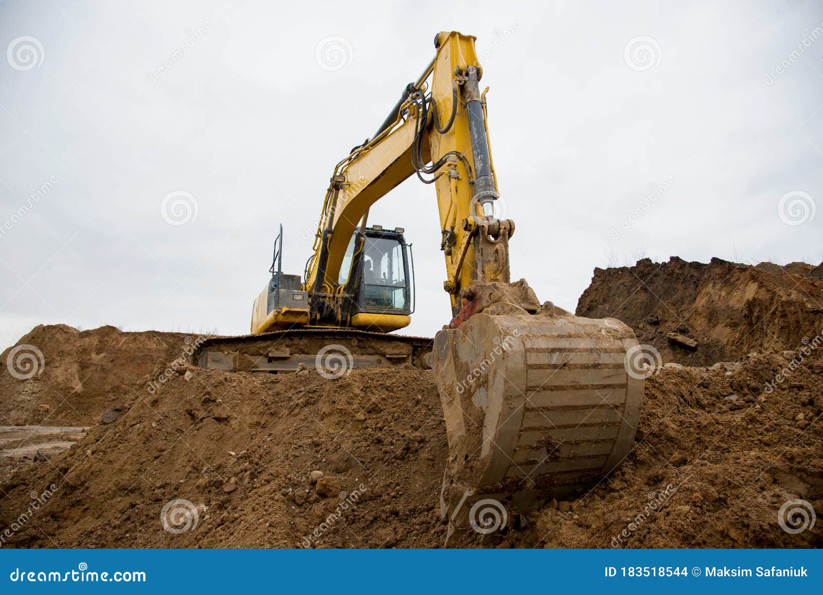 Track-type Excavator during Earthmoving at Construction Site. Backhoe ...