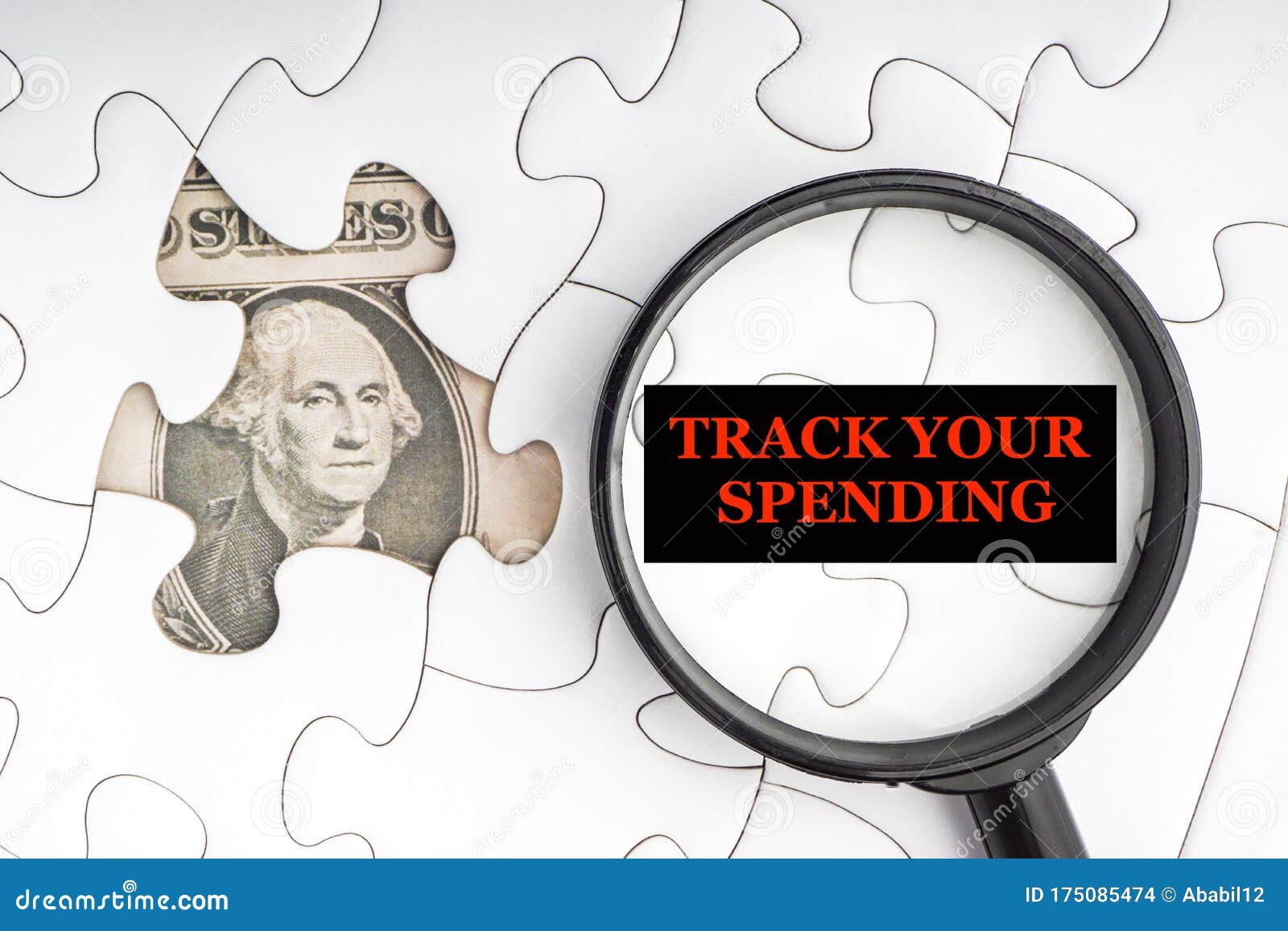 TRACKING YOUR SPENDING Text with Dollar Banknotes on White Jigsaw ...
