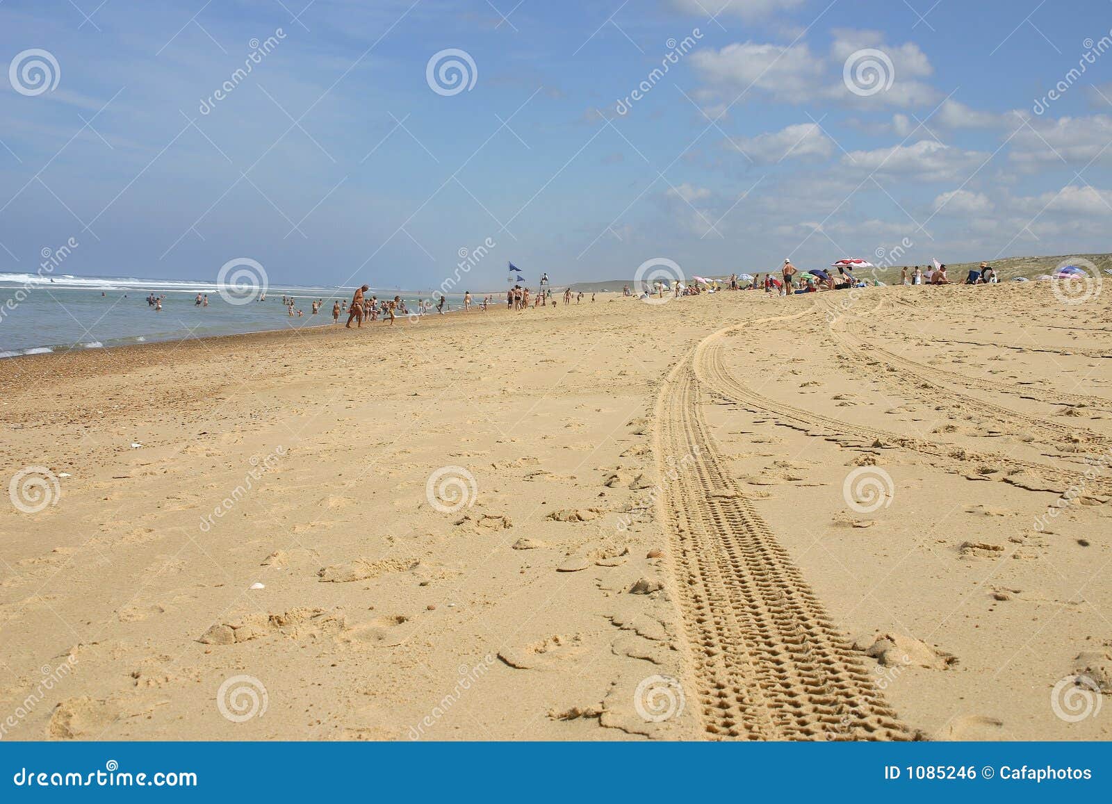 Tracks in sand stock photo. Image of flag, coastline, oceanic - 1085246