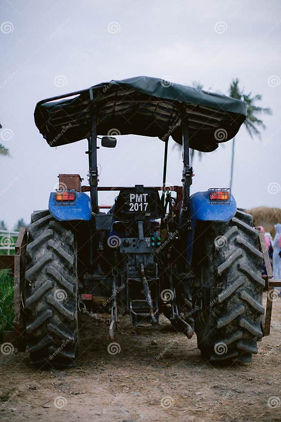 Blue tractor in the farm editorial photography. Image of farming ...