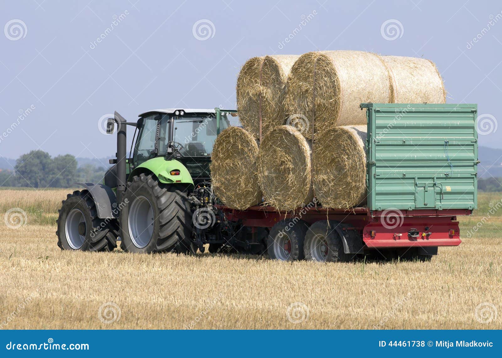 Tractor with Balls of Hay on an Agriculture Trailer. Stock Photo ...