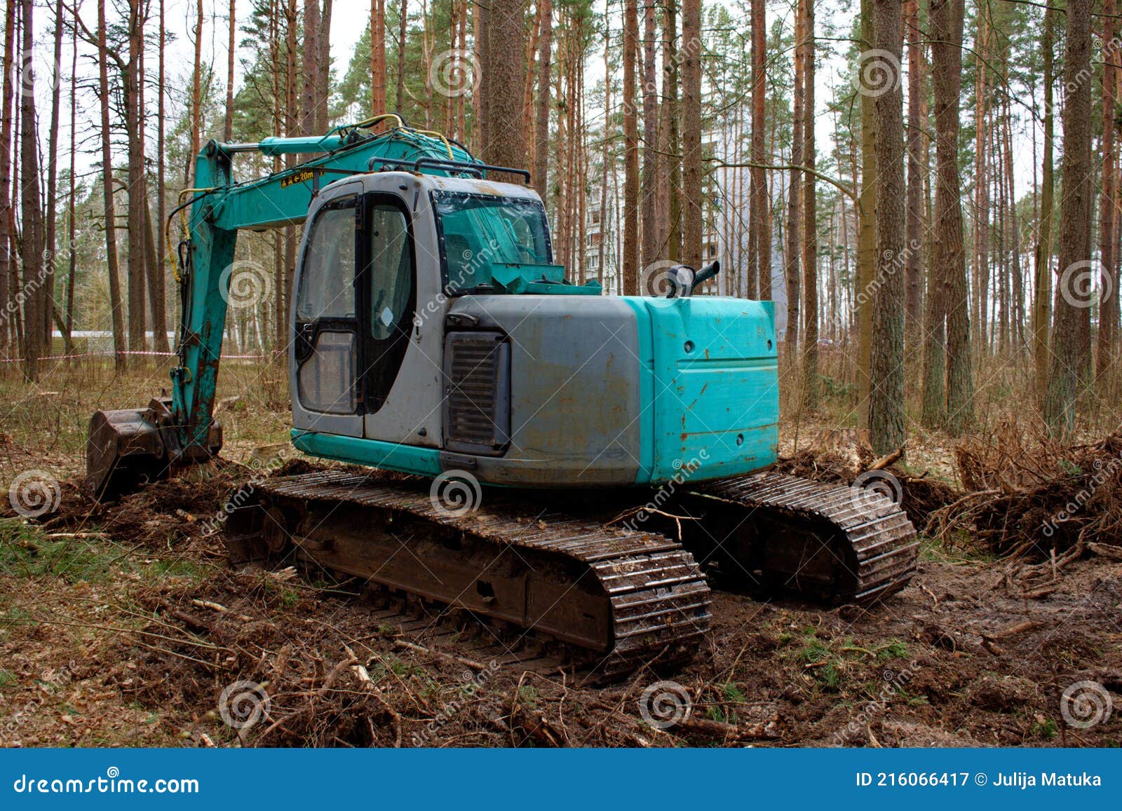 Tractor with a Bucket in the Forest. the Concept of Cutting Down Trees ...