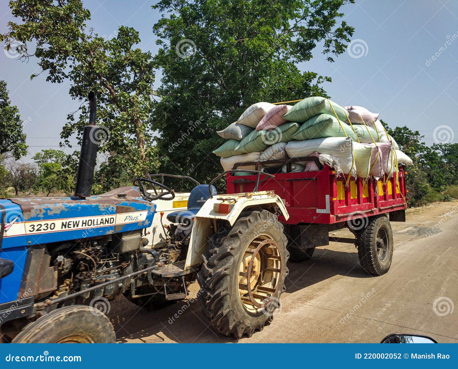 A Tractor is Carrying the Load of Grains. Stock Photo - Image of ...