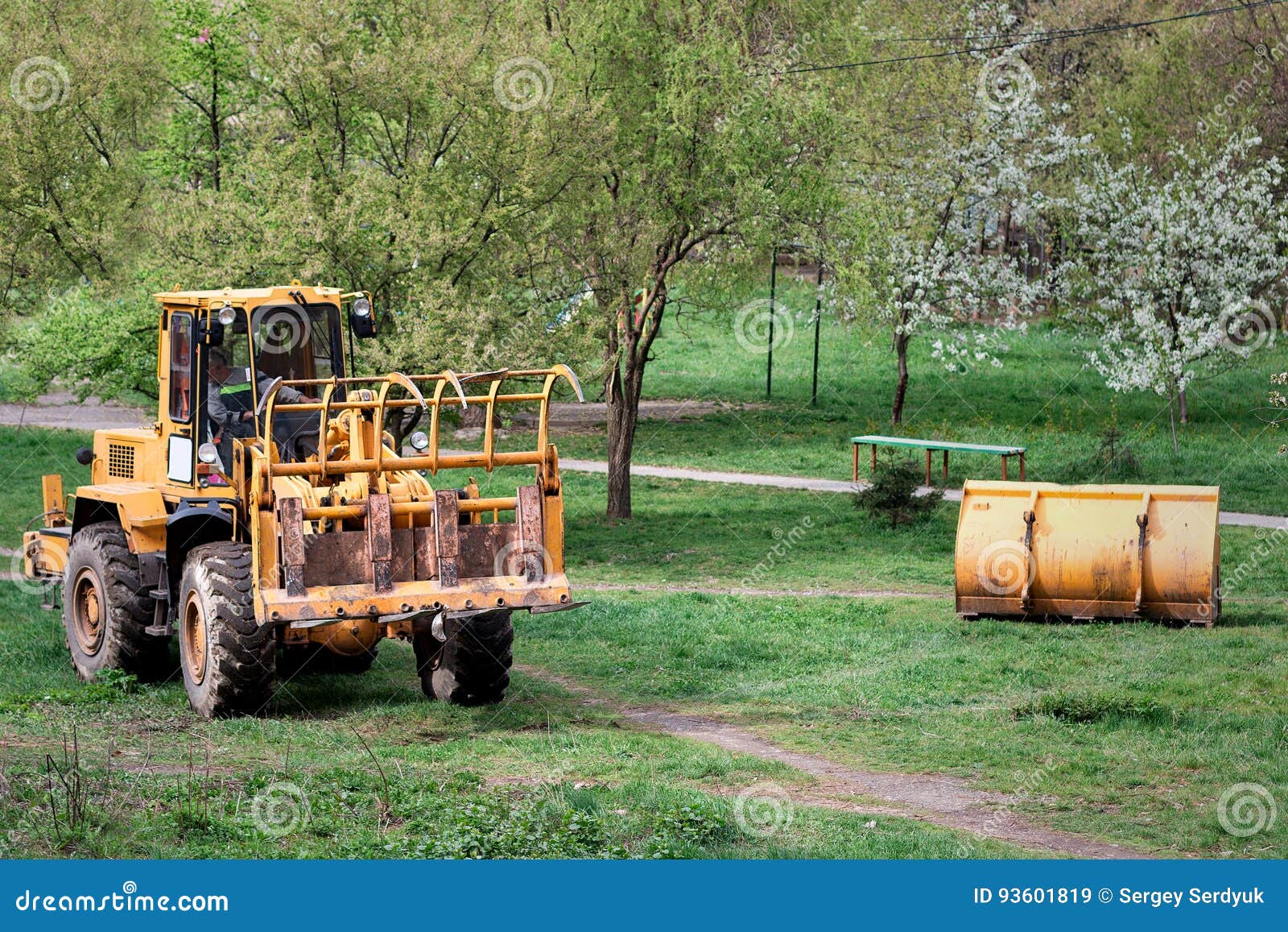 A Tractor with a Clamp instead of a Bucket Cleans Away Garbage, Stock ...