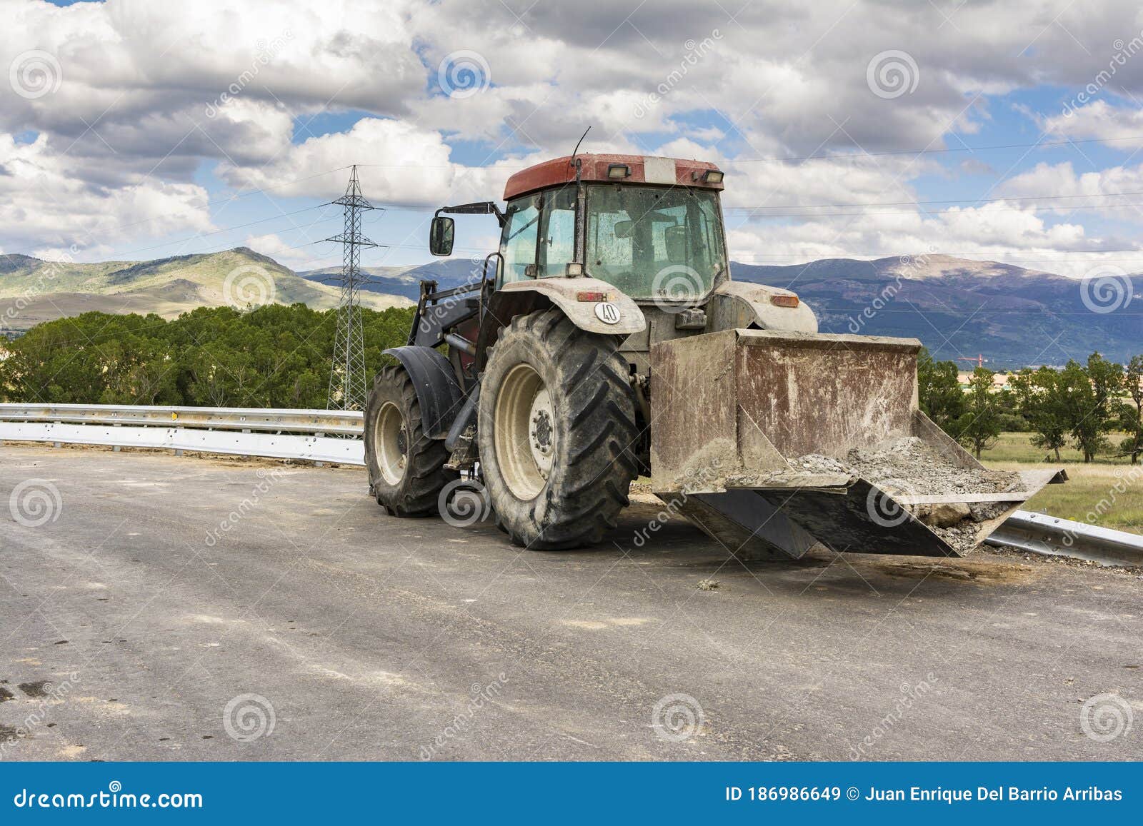 Tractor Constructing a Water Pipeline Ditch at Road Construction Works ...