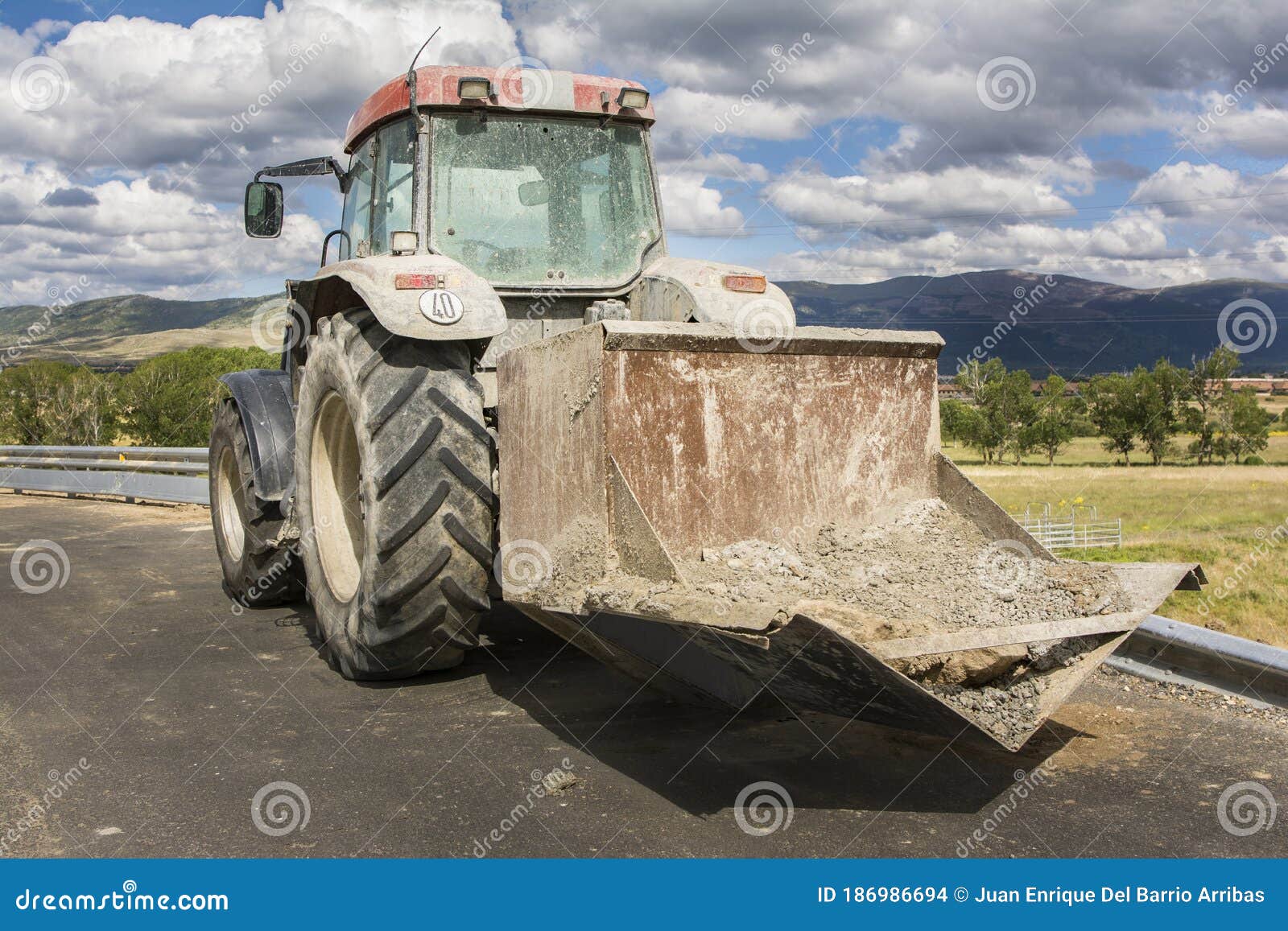 Tractor Constructing a Water Pipeline Ditch at Road Construction Works ...