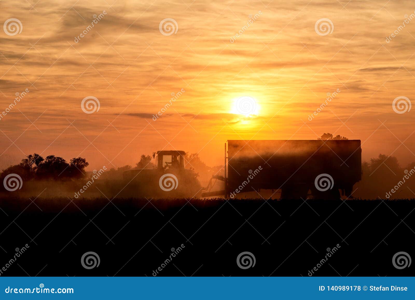 Tractor with Corn Trailer in Sunset Stock Photo - Image of harvest ...