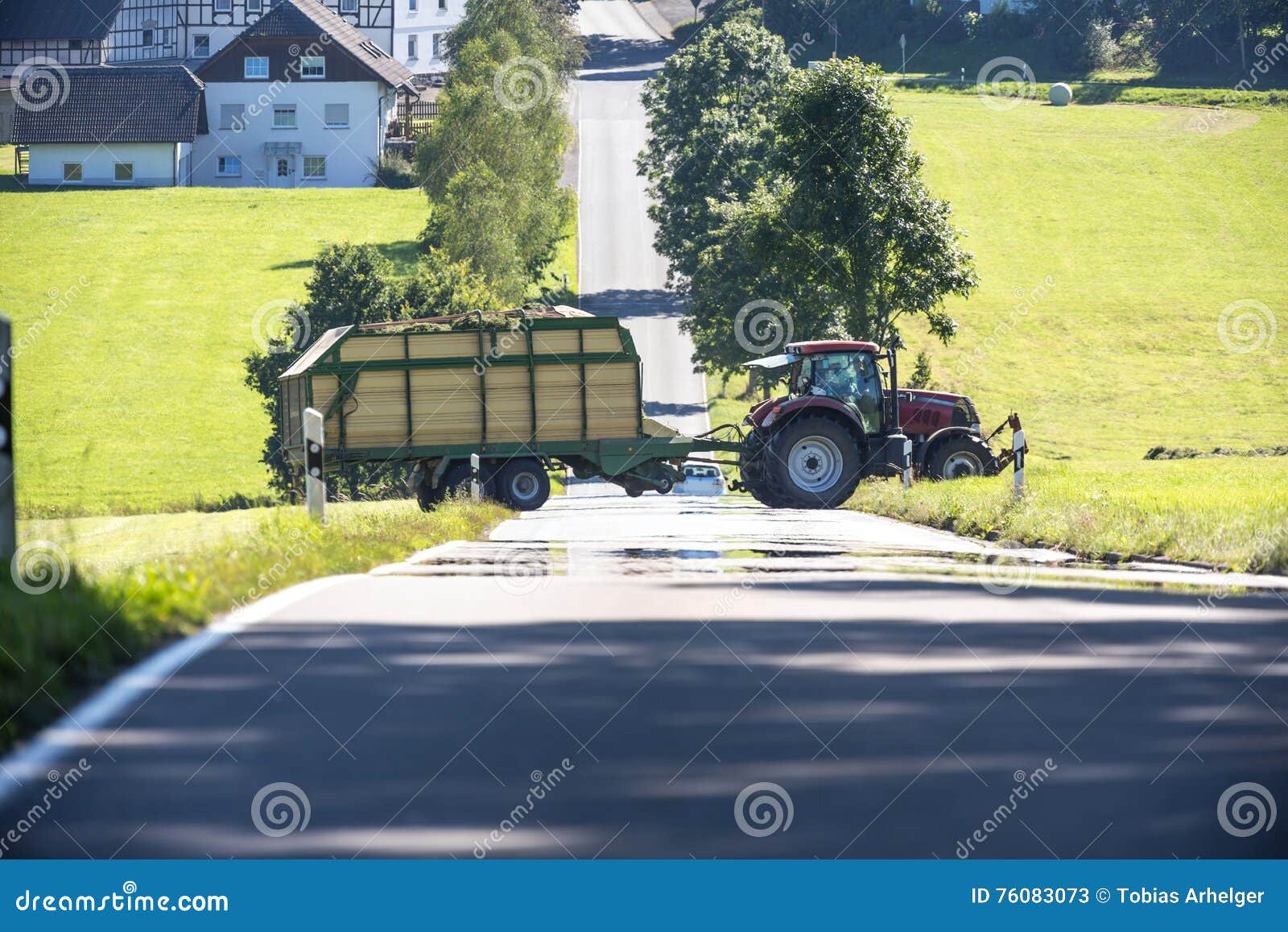 Tractor Crossing a Country Road Stock Image - Image of country, harvest ...