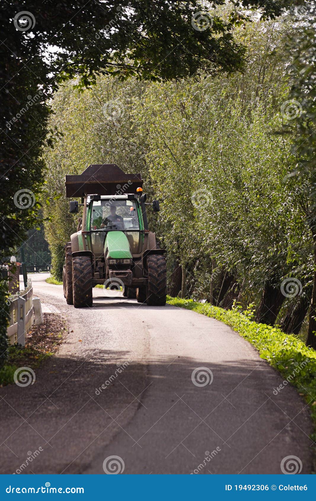 Tractor Driving on Country Road Stock Photo - Image of nature, green ...
