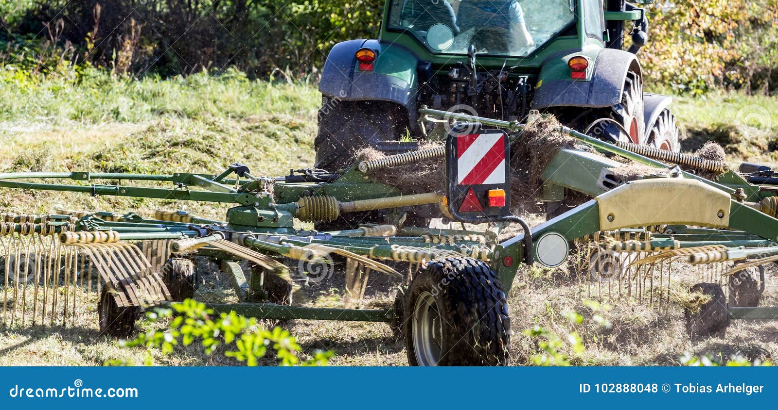 Tractor Drying Hay in a Hay Harvest Stock Photo - Image of tractor ...