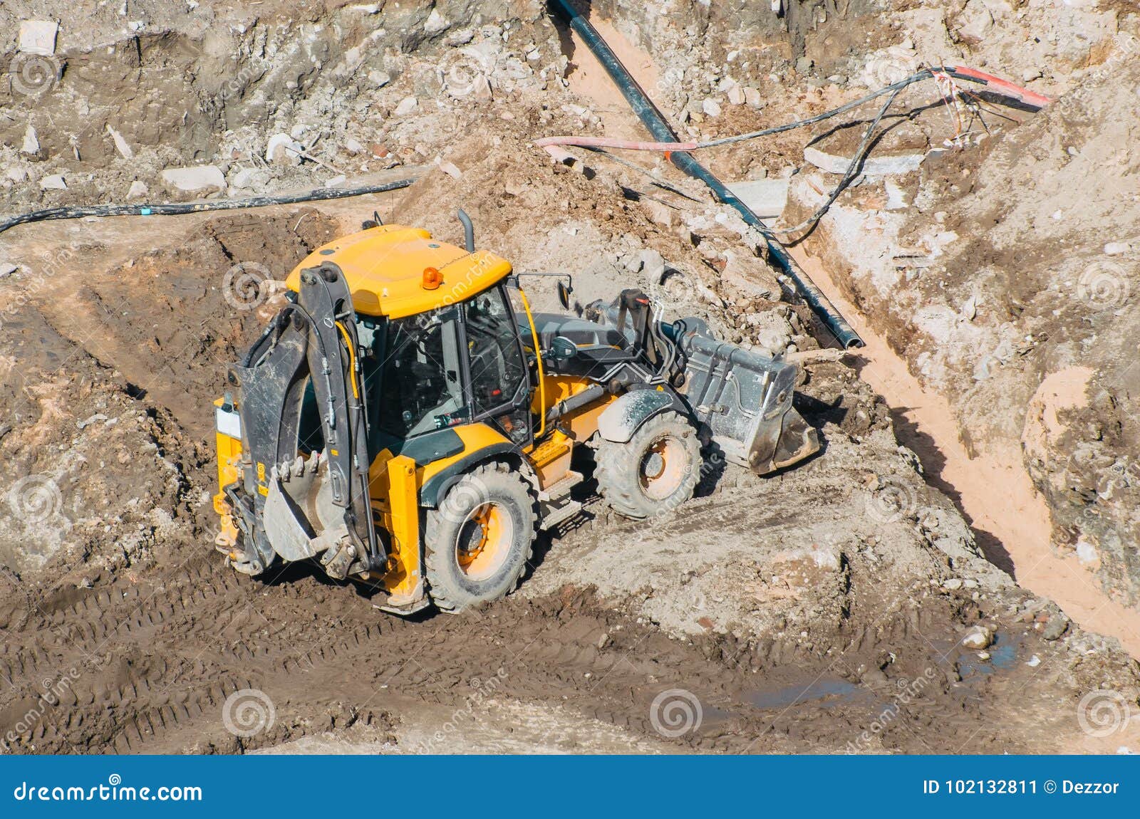 Tractor Excavator with Bucket Rides Running through Mud Lands Setting ...